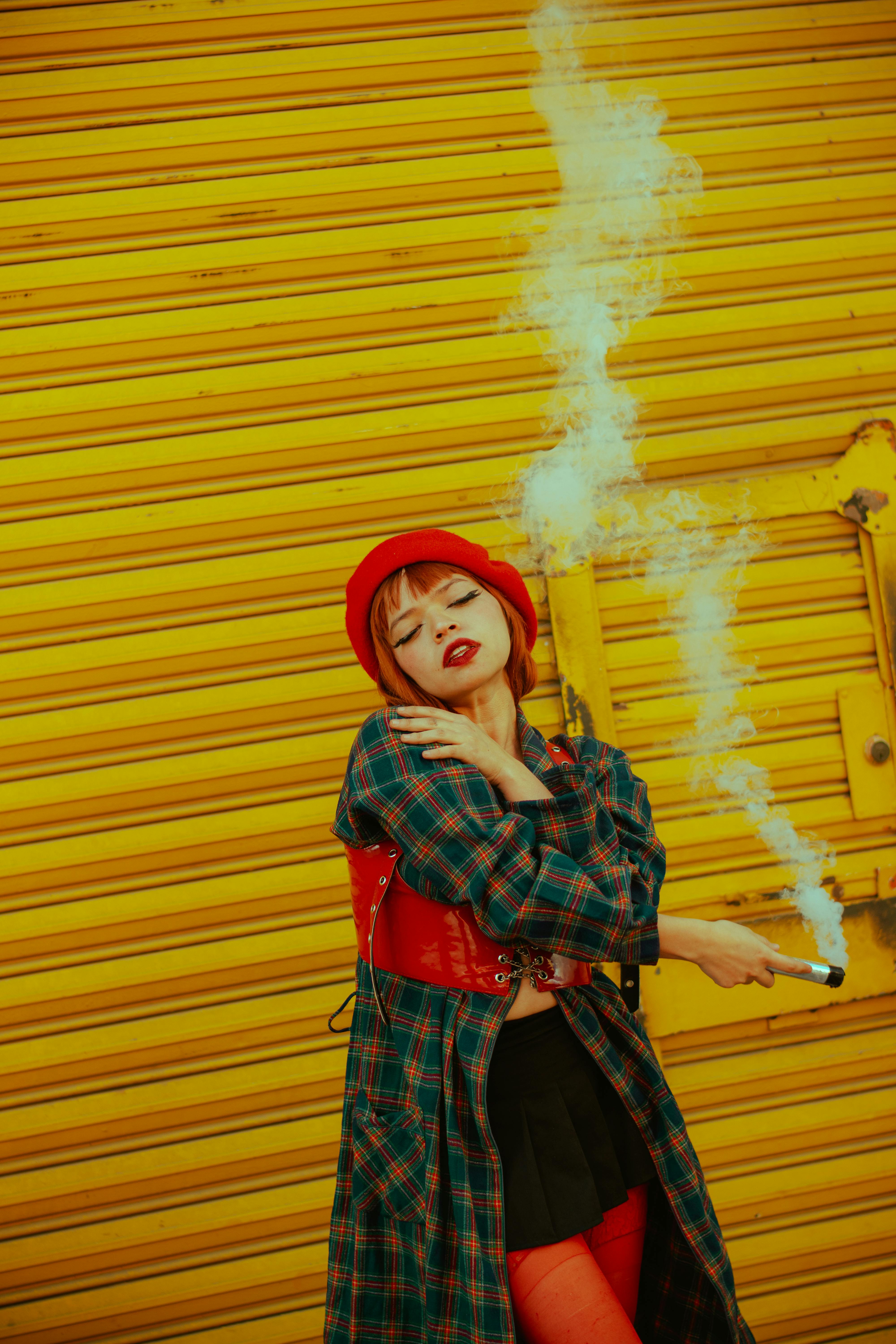 Stylish Woman Vaping against Yellow Background · Free Stock Photo