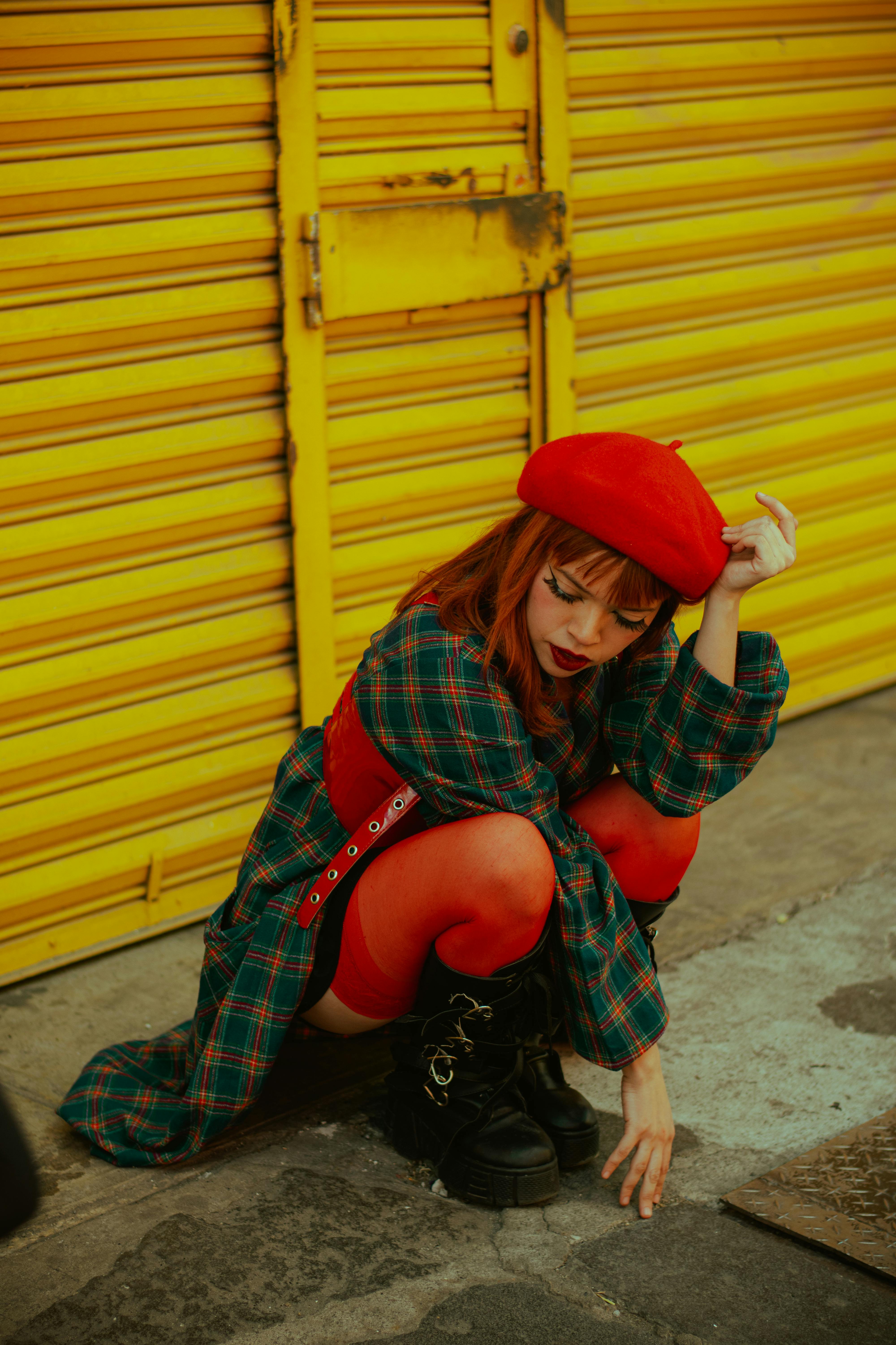 Fashionable Woman Posing Near Yellow Shutters · Free Stock Photo