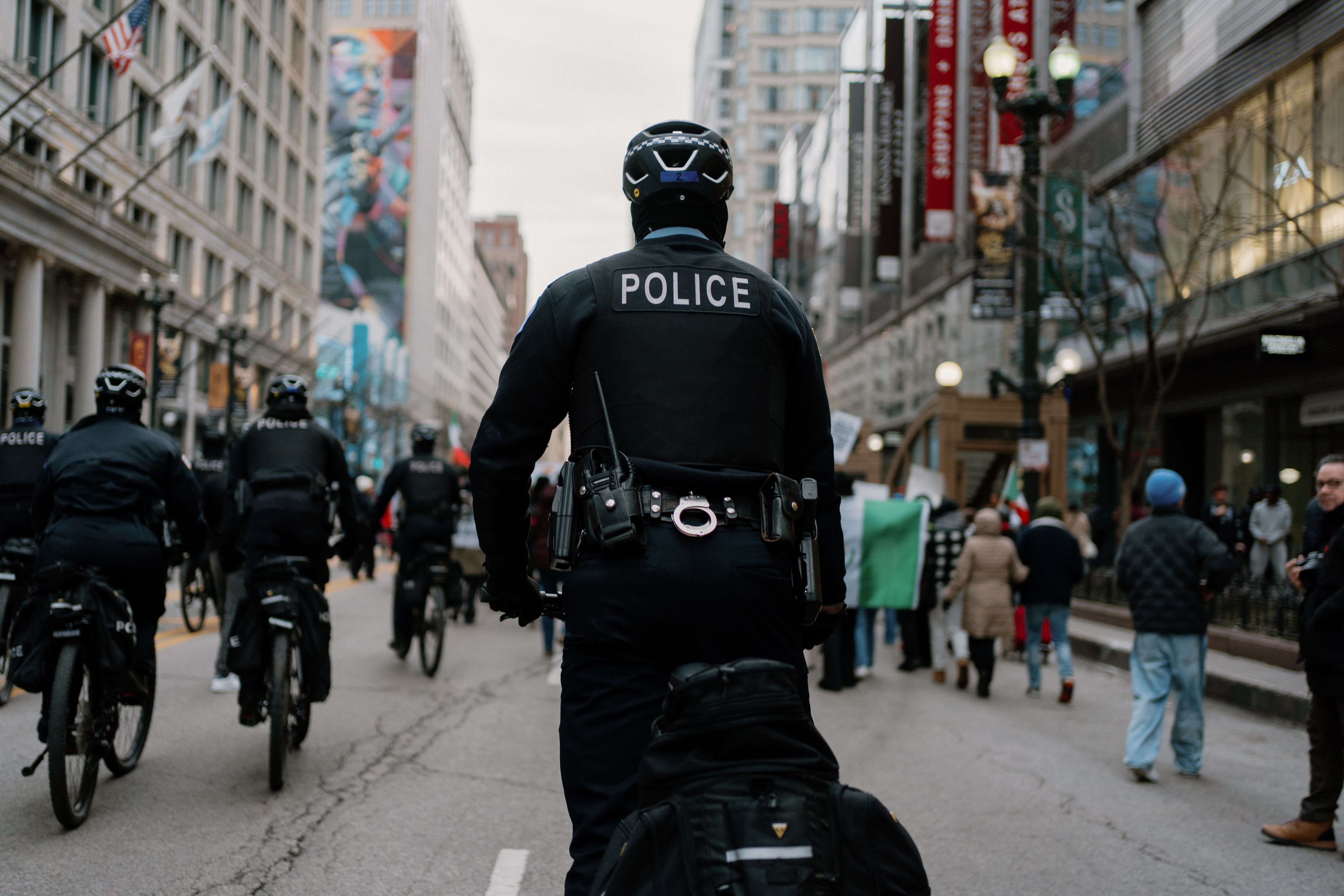 Urban street with police officers in patrol gear · Free Stock Photo