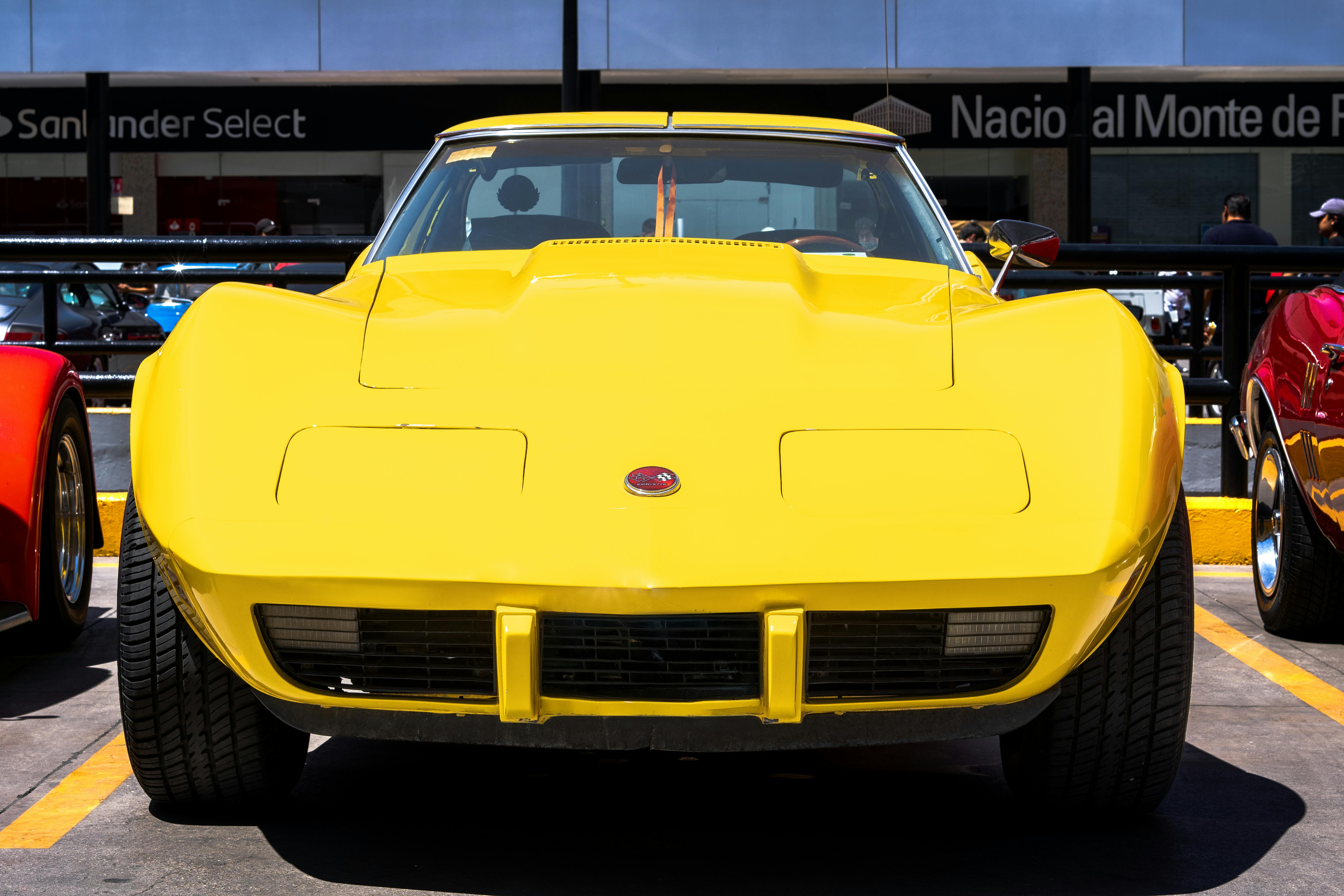 Vintage Yellow Sports Car on Display in Parking Lot · Free Stock Photo