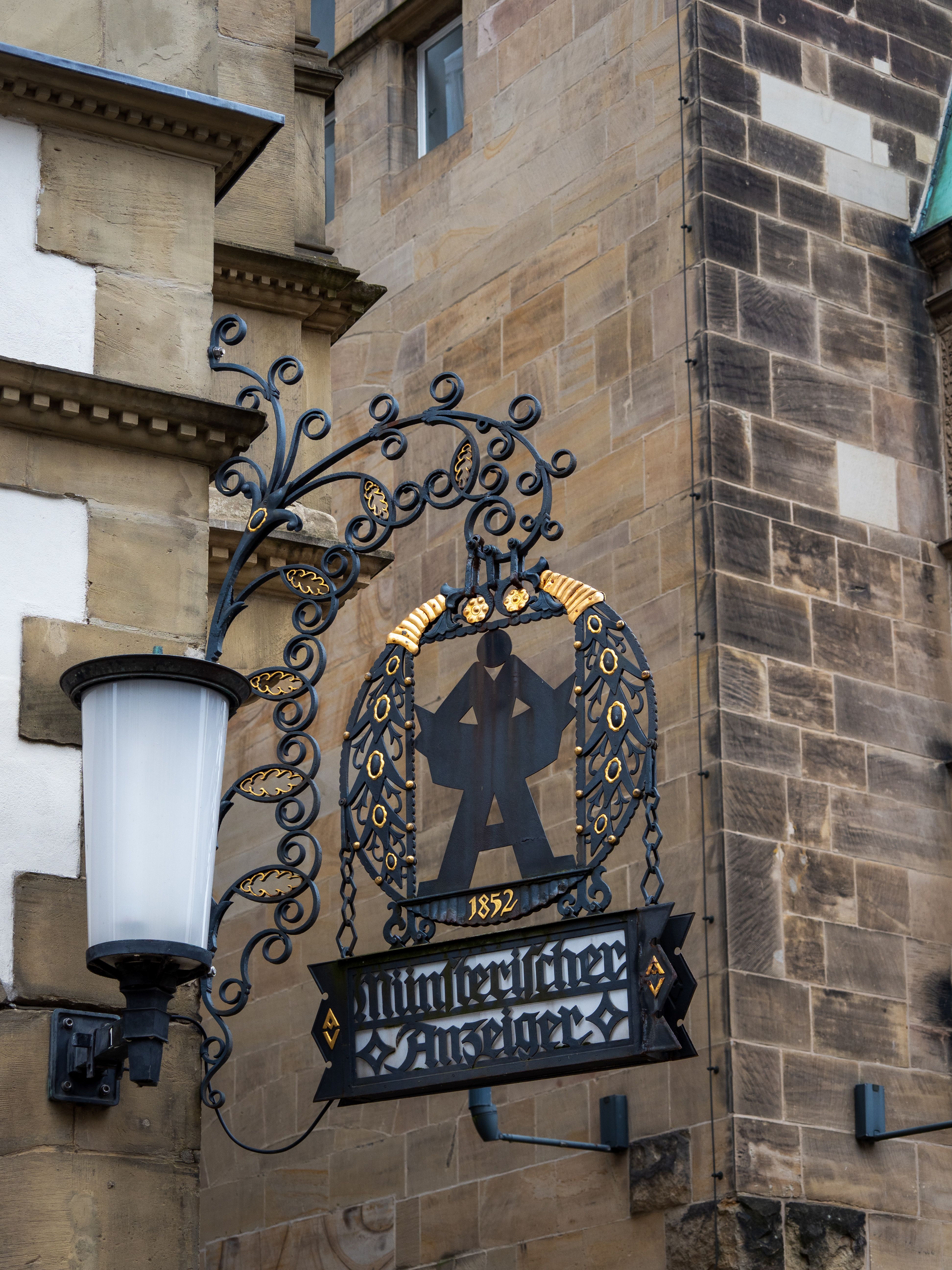 Wrought Iron Sign in Historical Urban Setting · Free Stock Photo