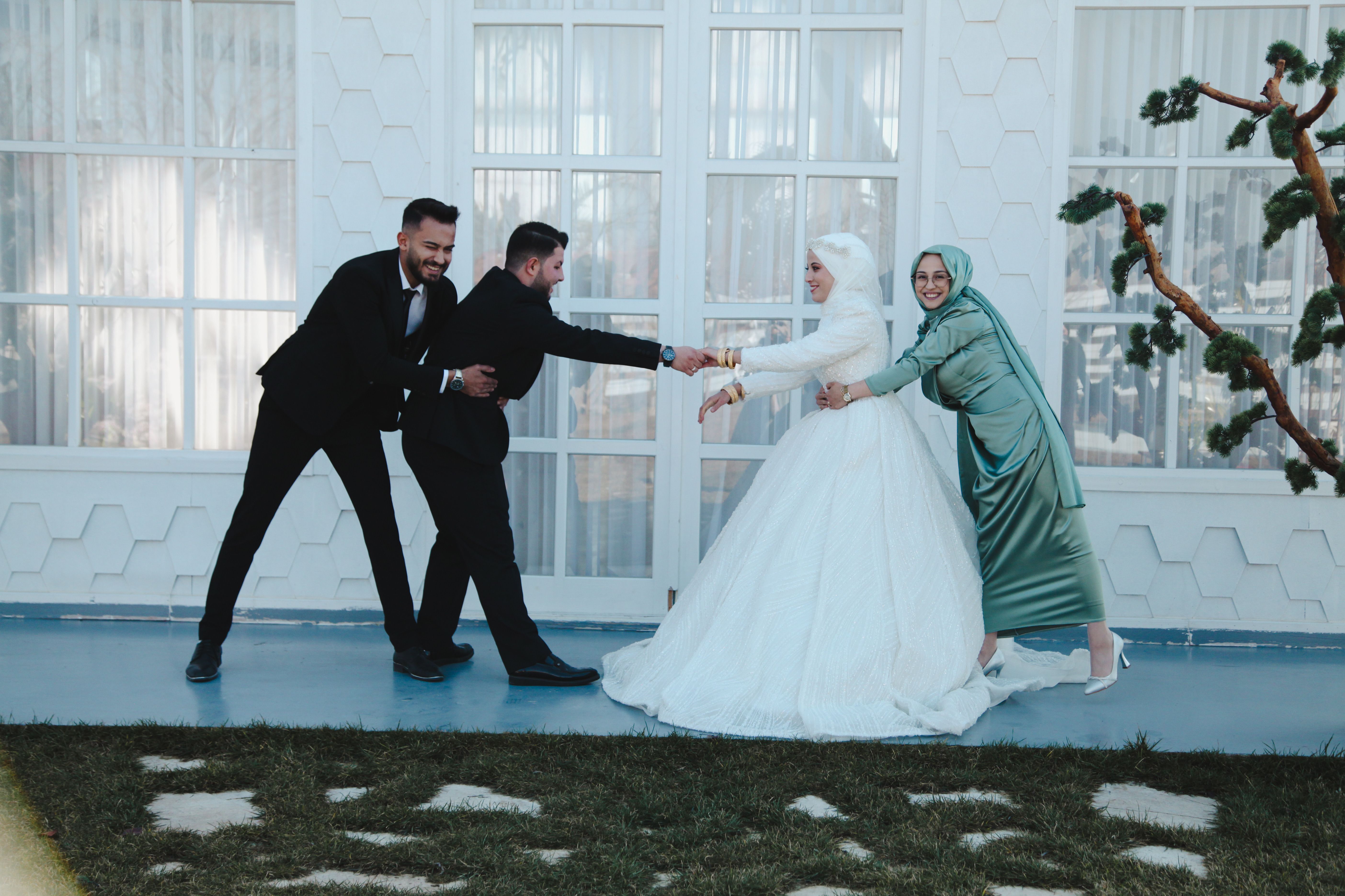 Playful Wedding Day Portrait with Friends Outdoors · Free Stock Photo