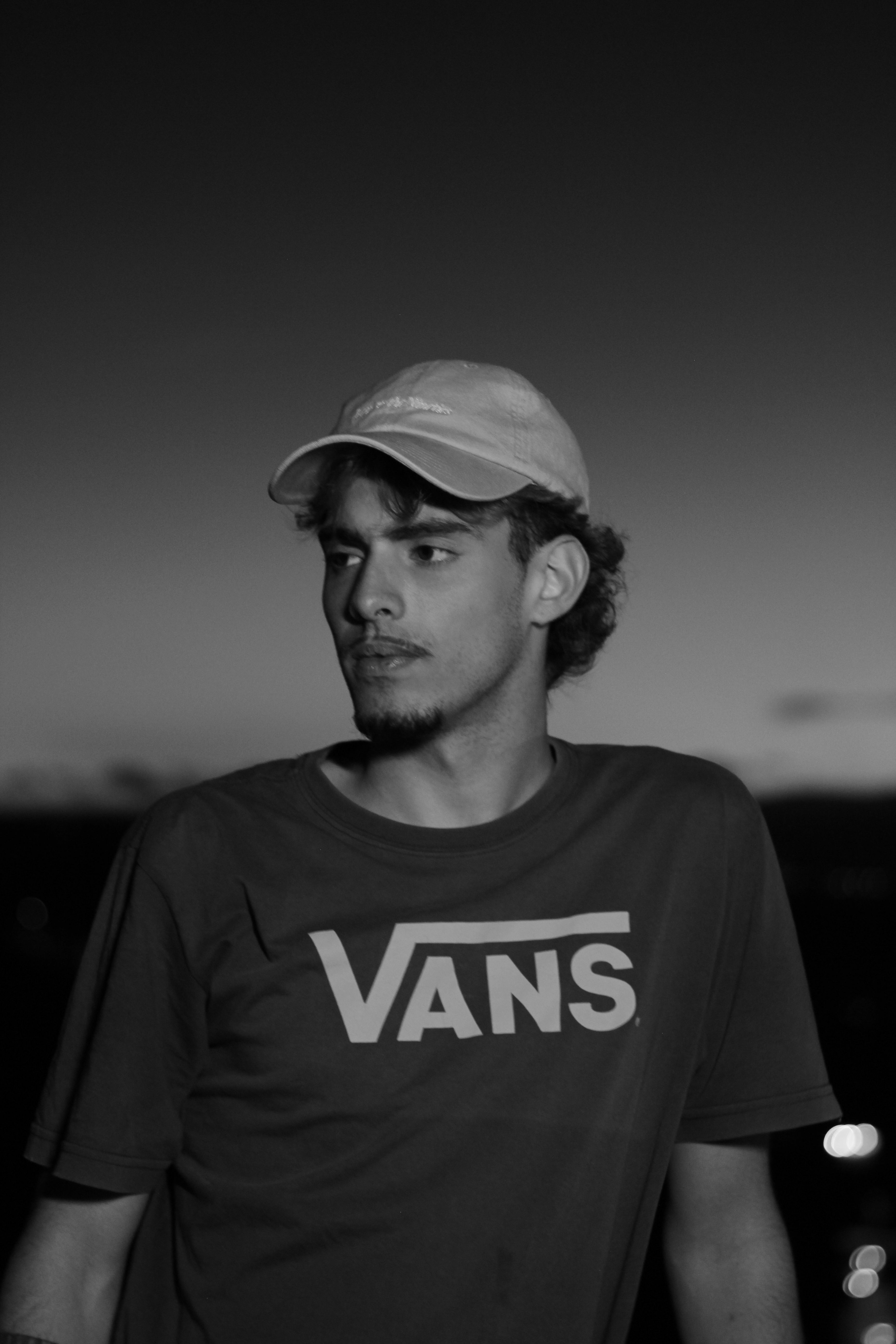 Black and White Portrait of a Man in Vans Tee · Free Stock Photo