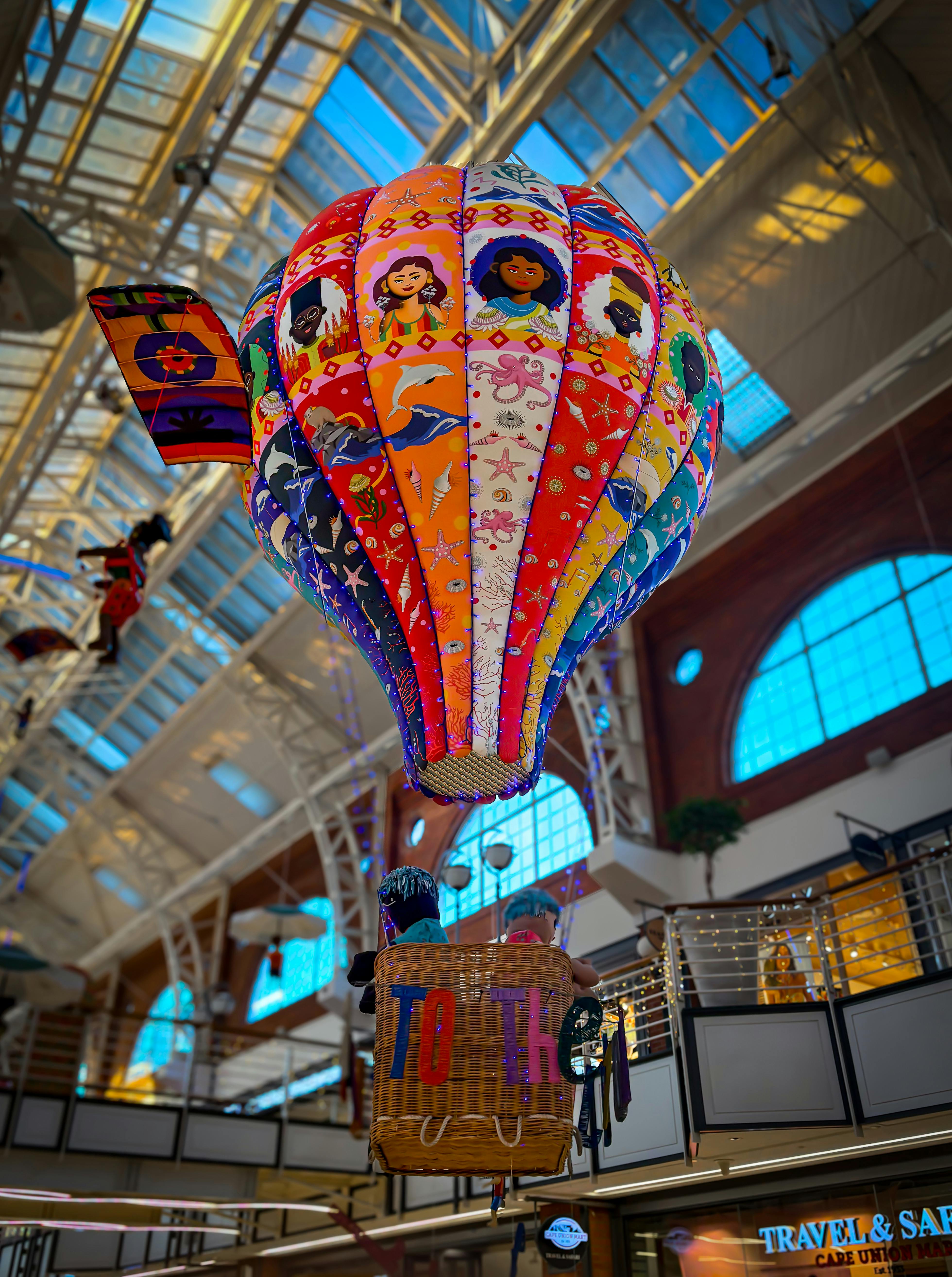 Vibrant Hot Air Balloon Display in Shopping Arcade · Free Stock Photo