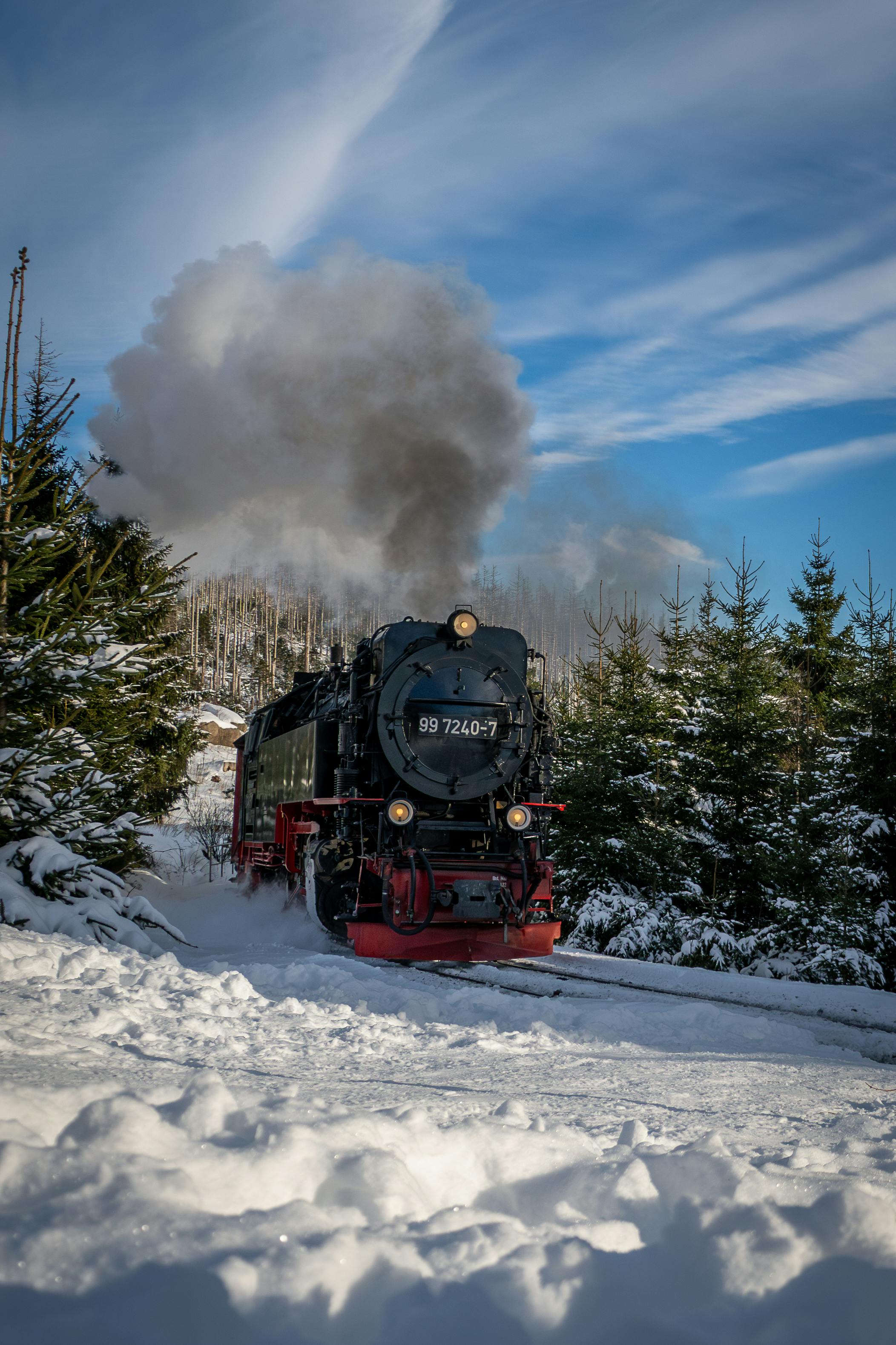 Steam Train Crossing Snowy Landscape in Winter · Free Stock Photo