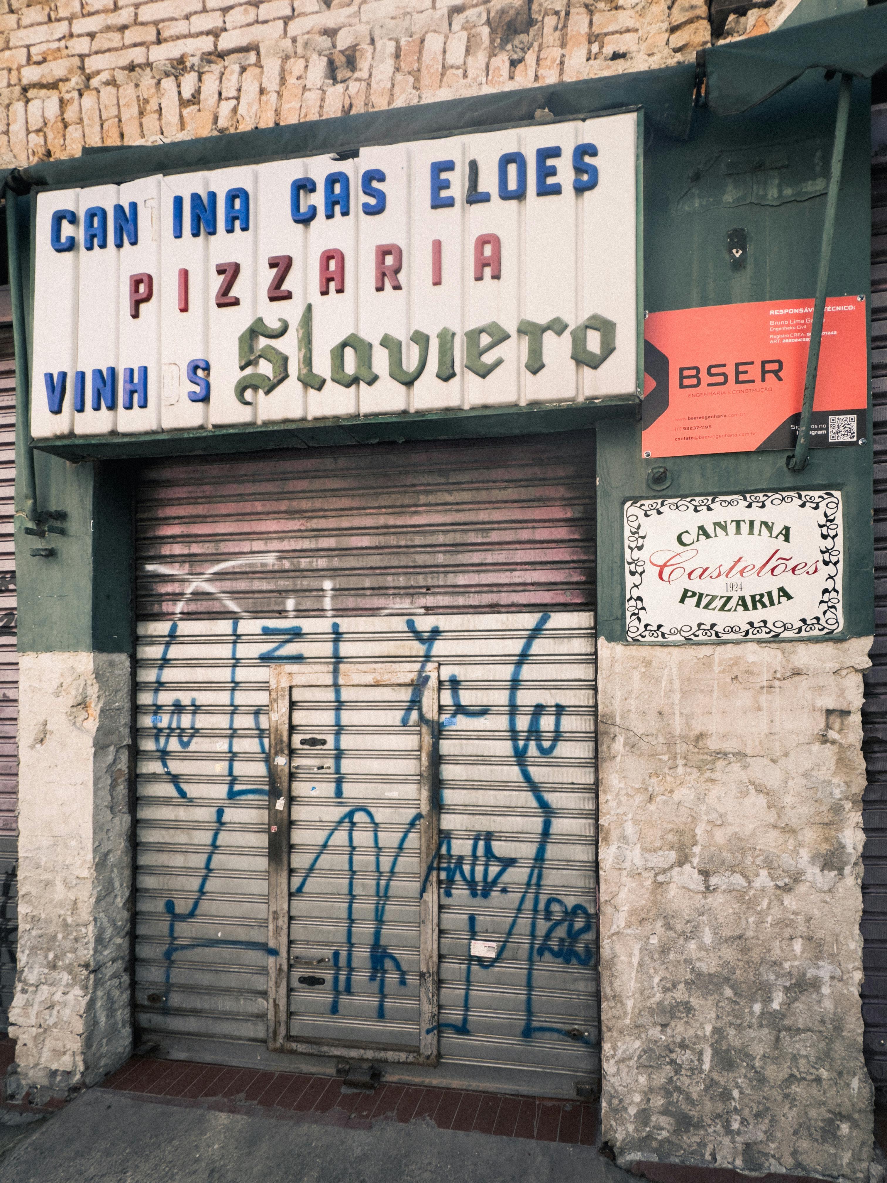 Urban Graffiti on Closed Pizzeria Storefront · Free Stock Photo
