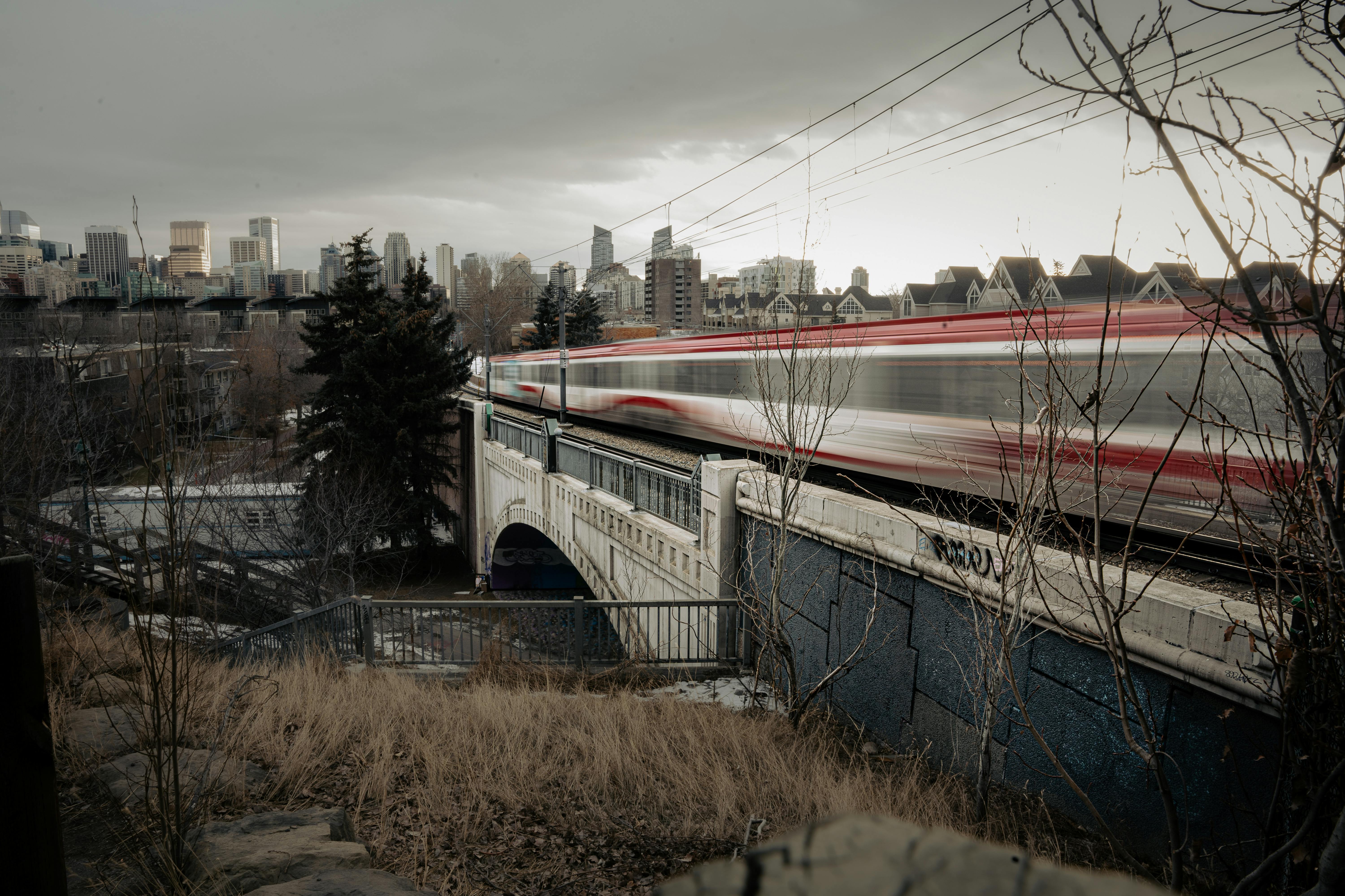 High-speed Train Passing Through Calgary Bridge · Free Stock Photo
