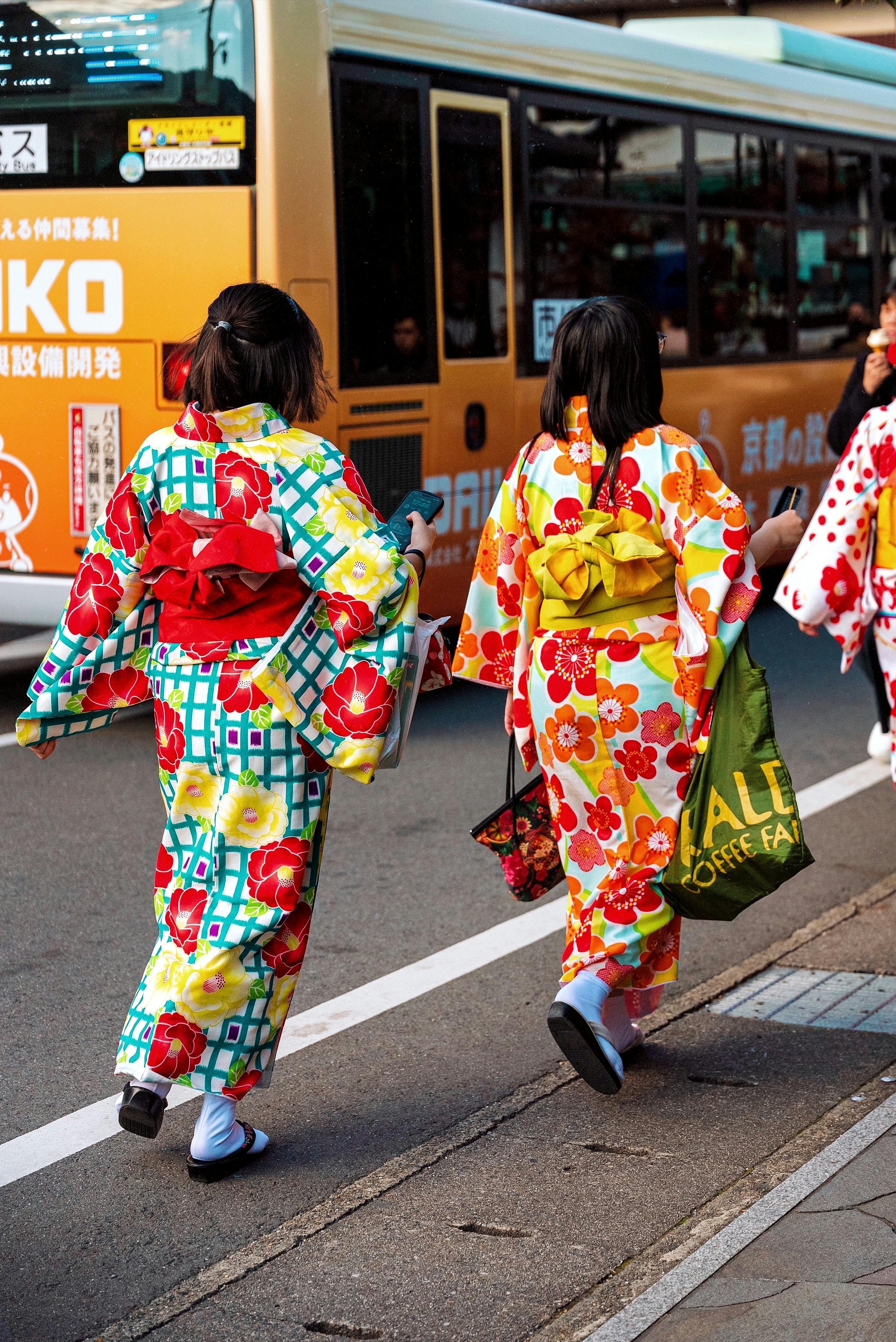 Young Women in Colorful Kimonos Walking Urban Street · Free Stock Photo