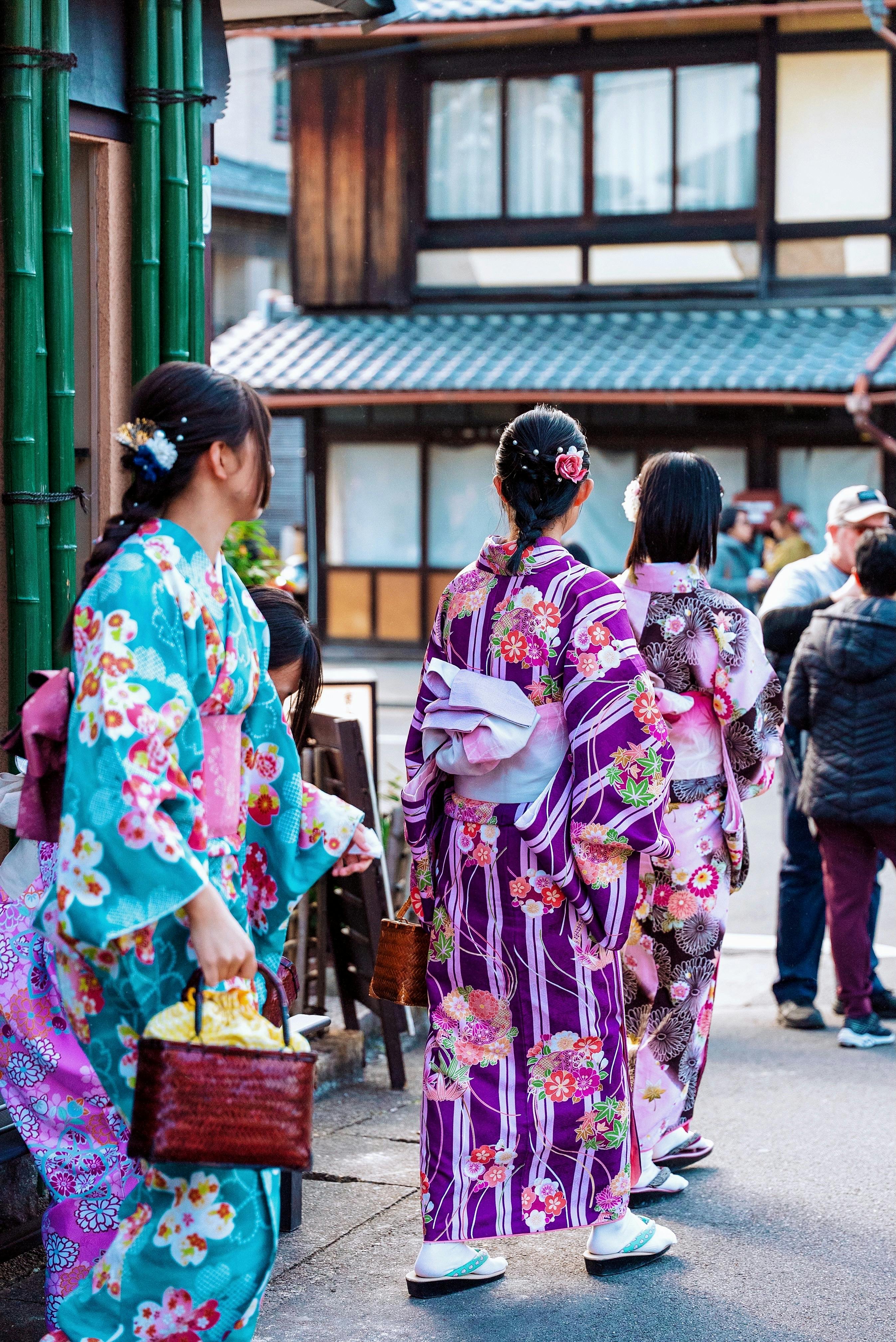 Japanese women in colorful kimonos walking outdoors · Free Stock Photo
