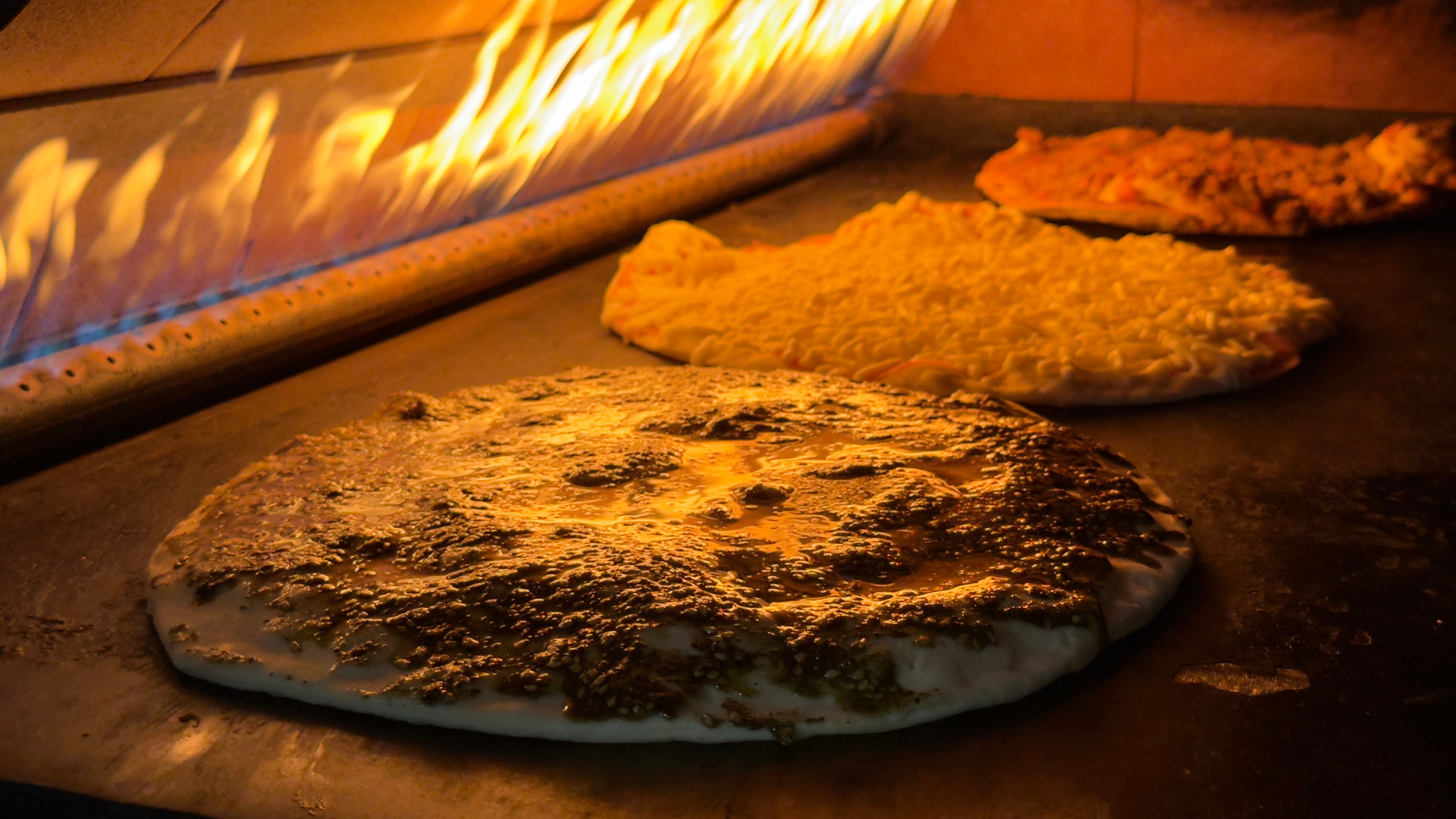 Traditional Lebanese Manakish Baking in Oven · Free Stock Photo