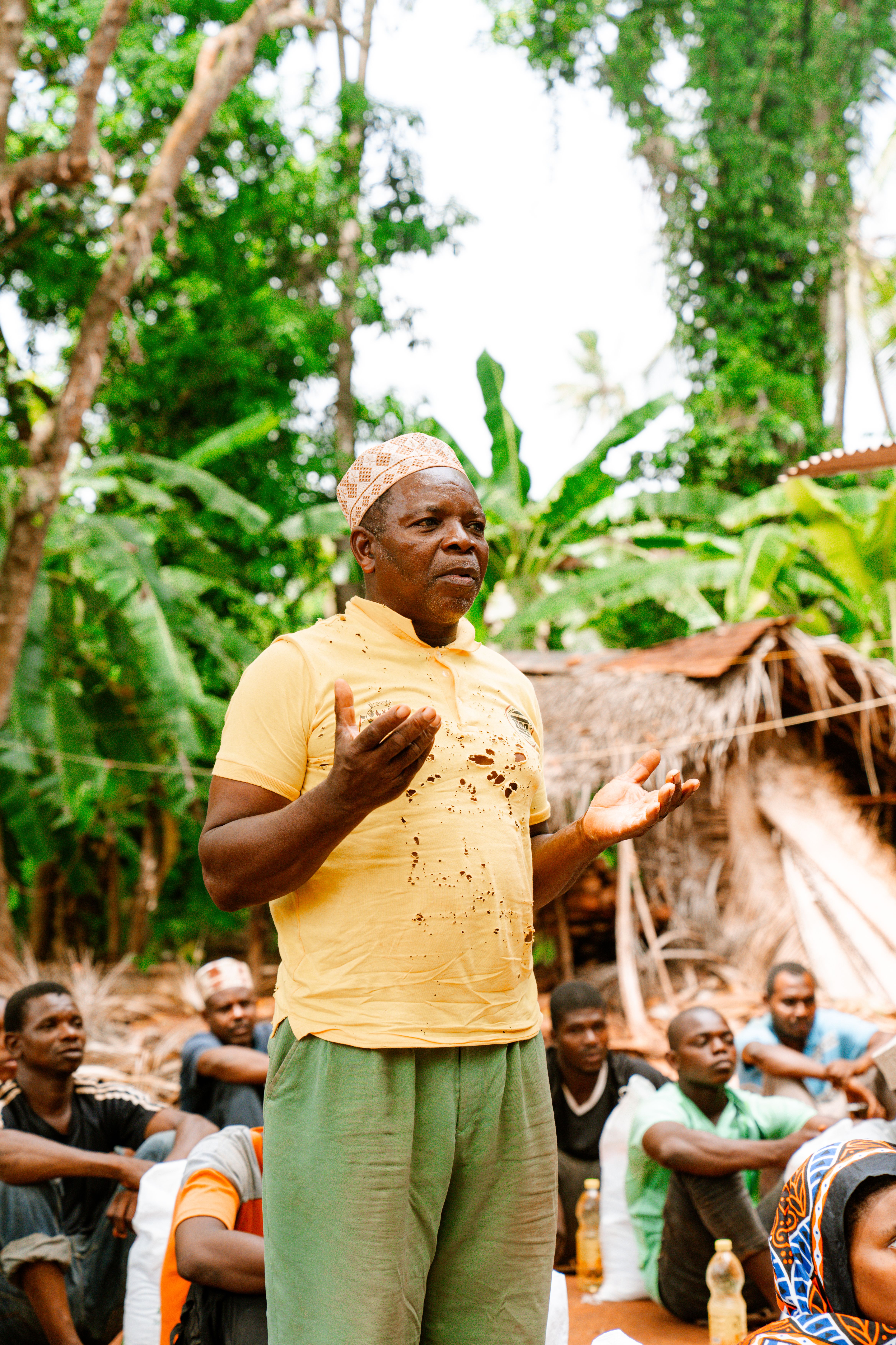 Community Leader Speaking in Tropical Setting · Free Stock Photo