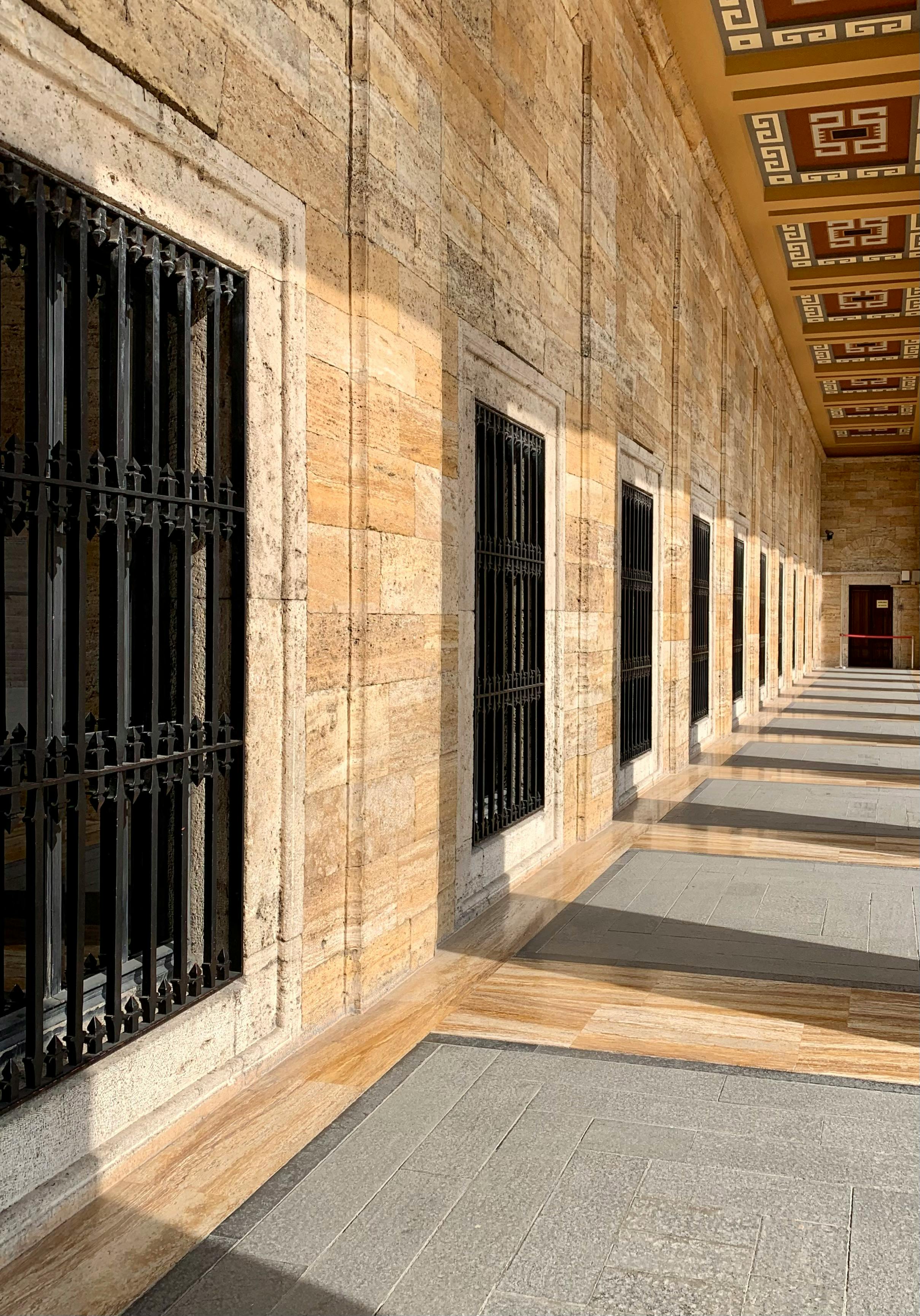 Elegant Stone Corridor with Intricate Ceiling Art · Free Stock Photo