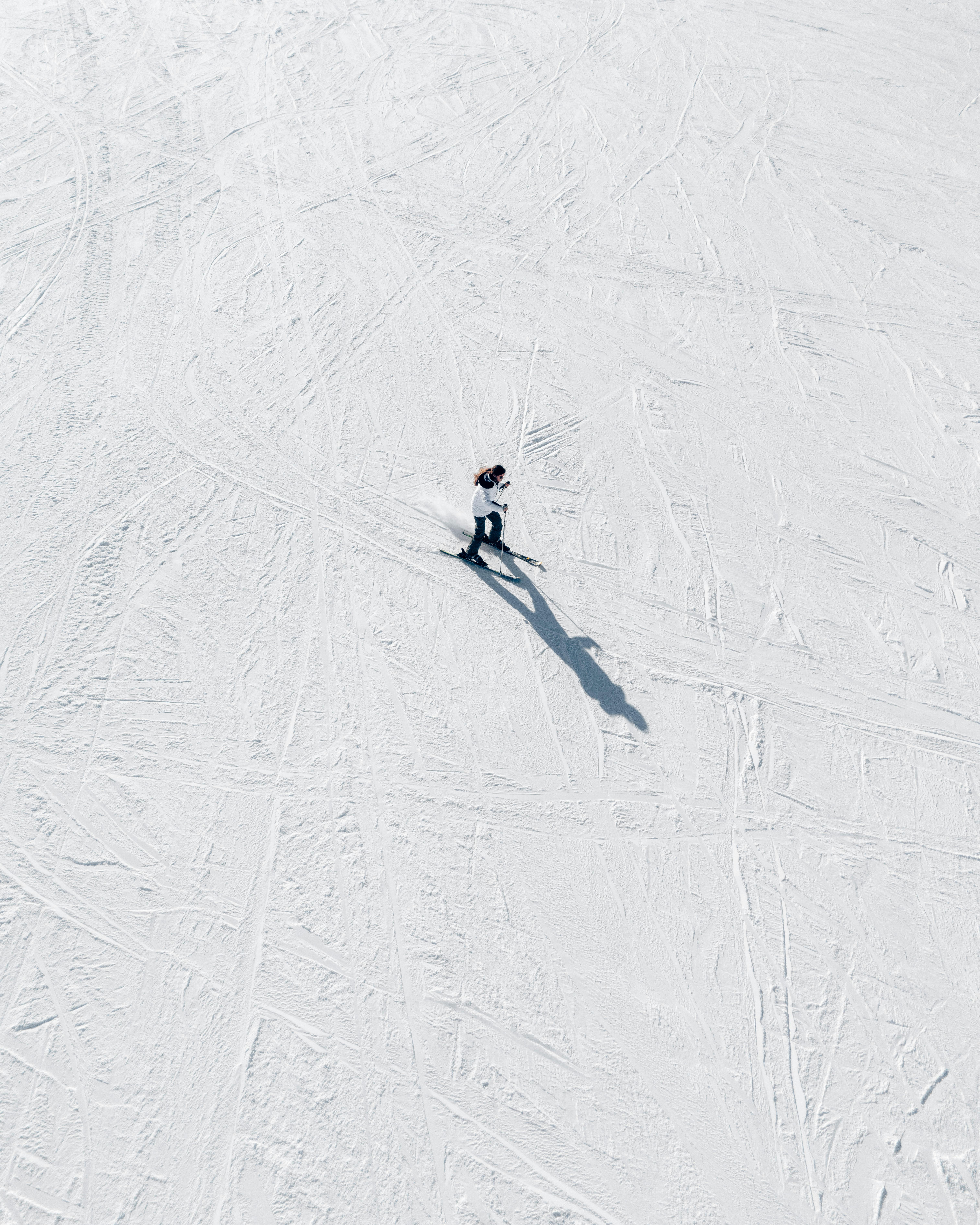 Lone Snowboarder on Vast Snowy Slope Aerial View · Free Stock Photo