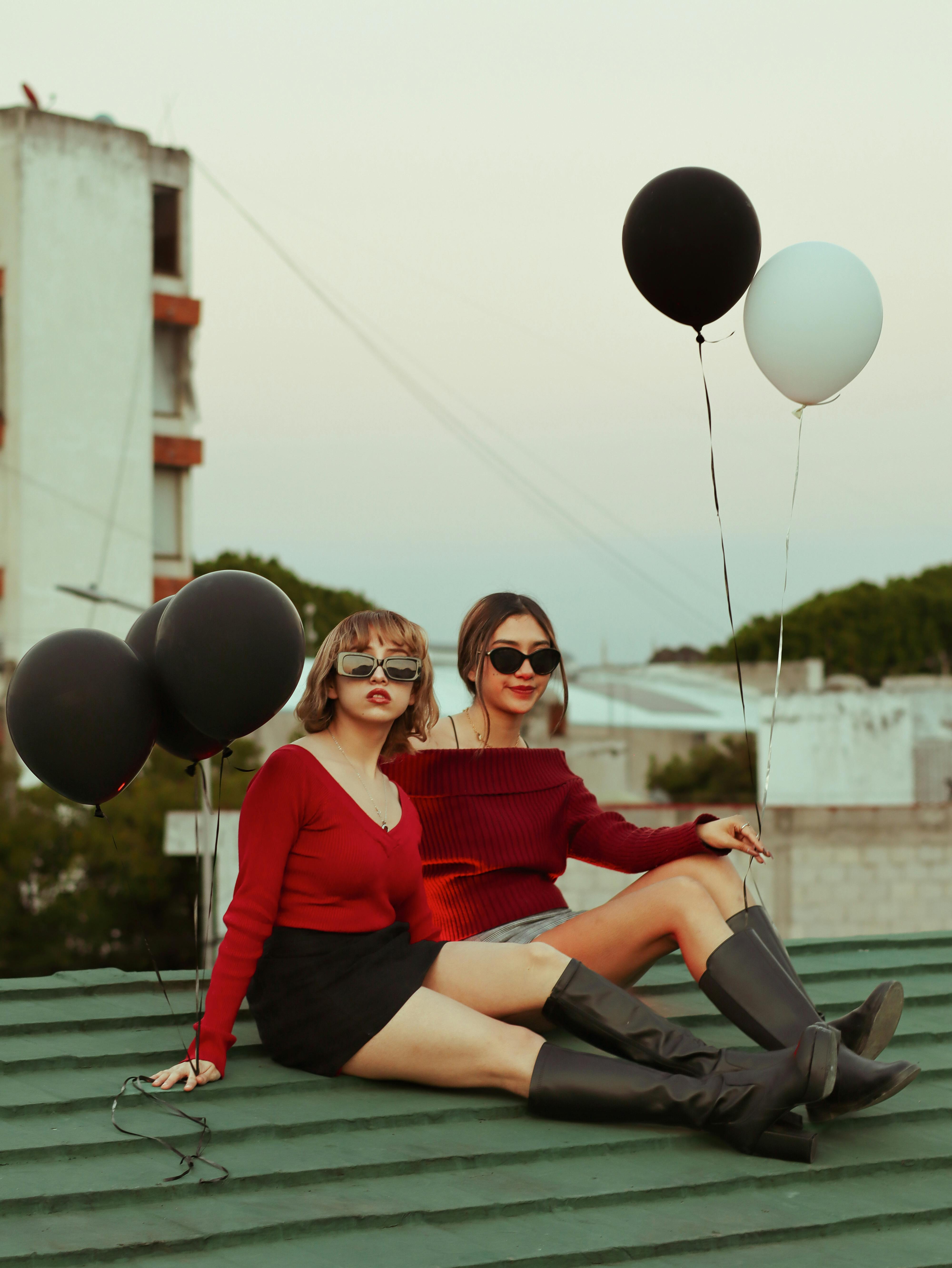 Fashionable women with balloons on rooftop · Free Stock Photo