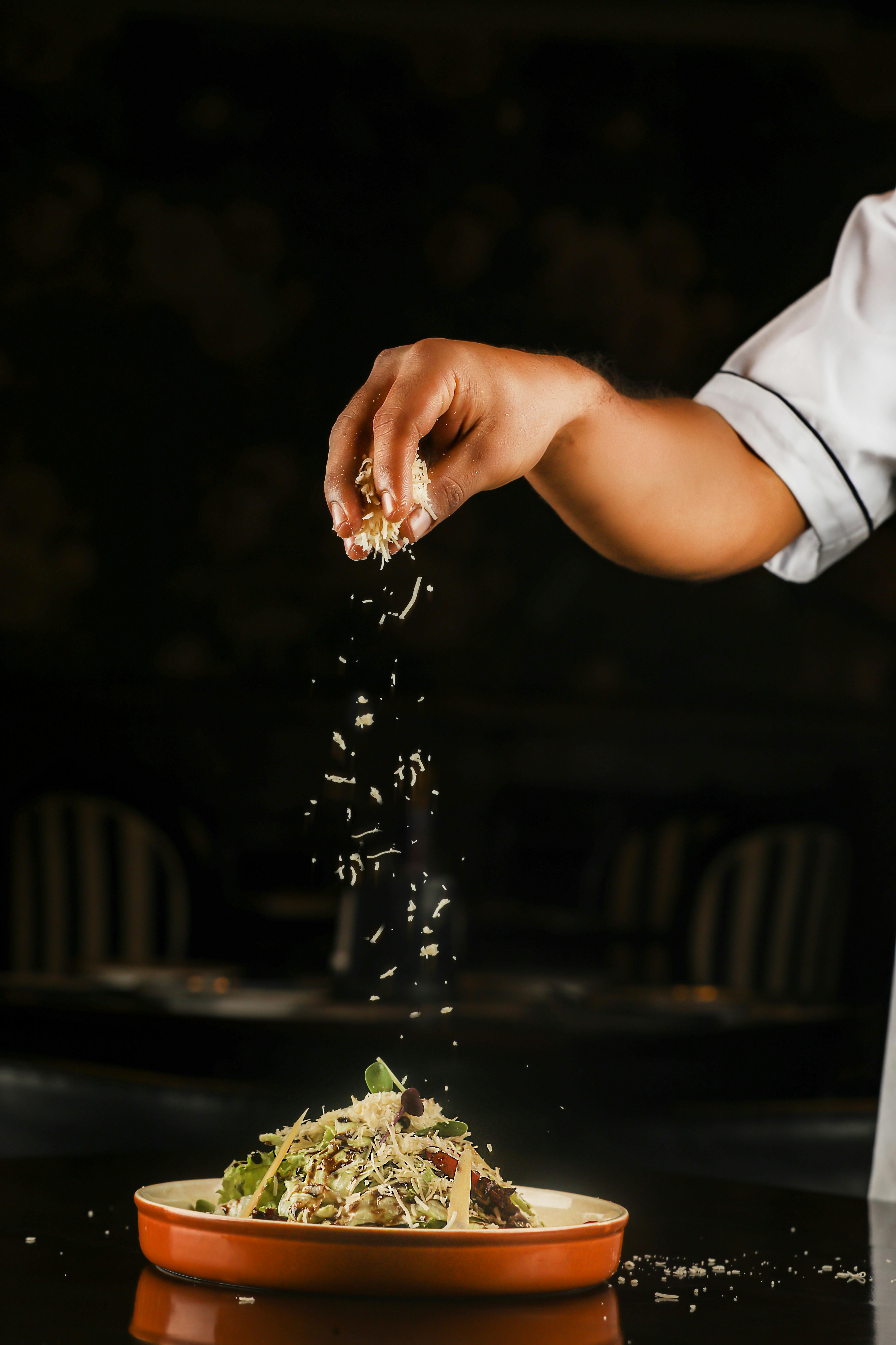 Chef Sprinkling Seasoning on Gourmet Dish · Free Stock Photo