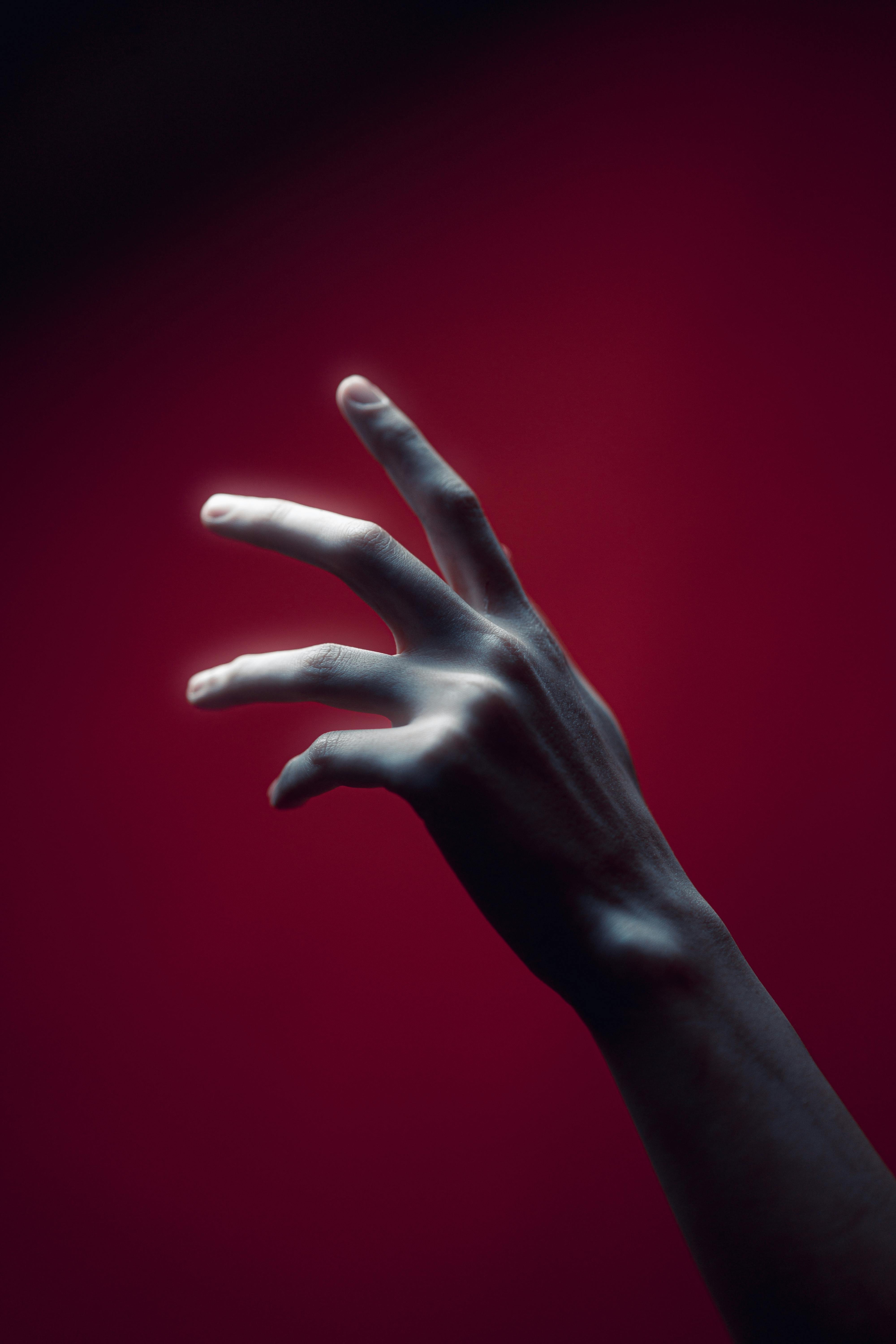 Abstract Artistic Hand on Red Background · Free Stock Photo