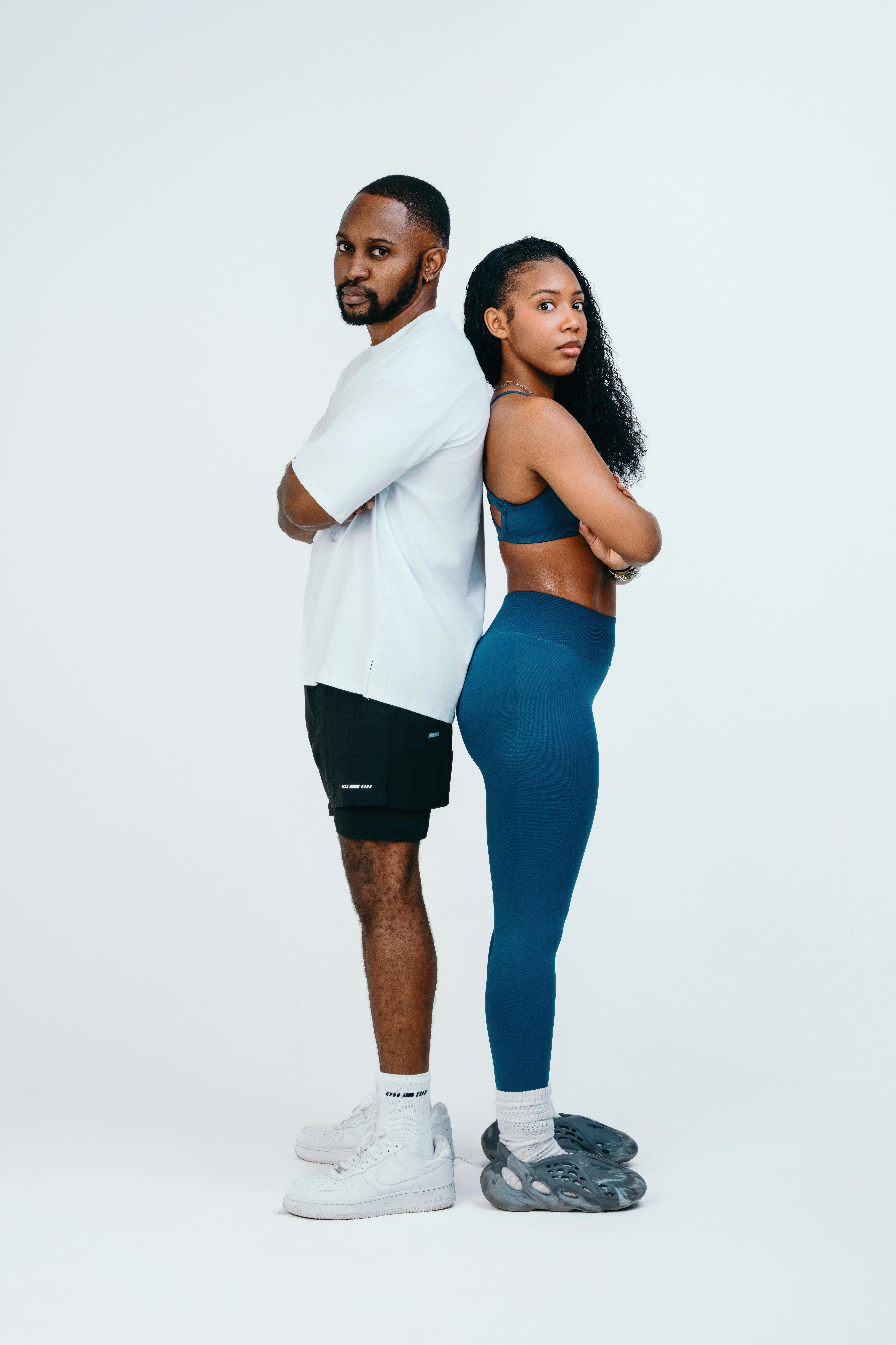 Dynamic Fitness Duo Back-to-Back Studio Portrait · Free Stock Photo