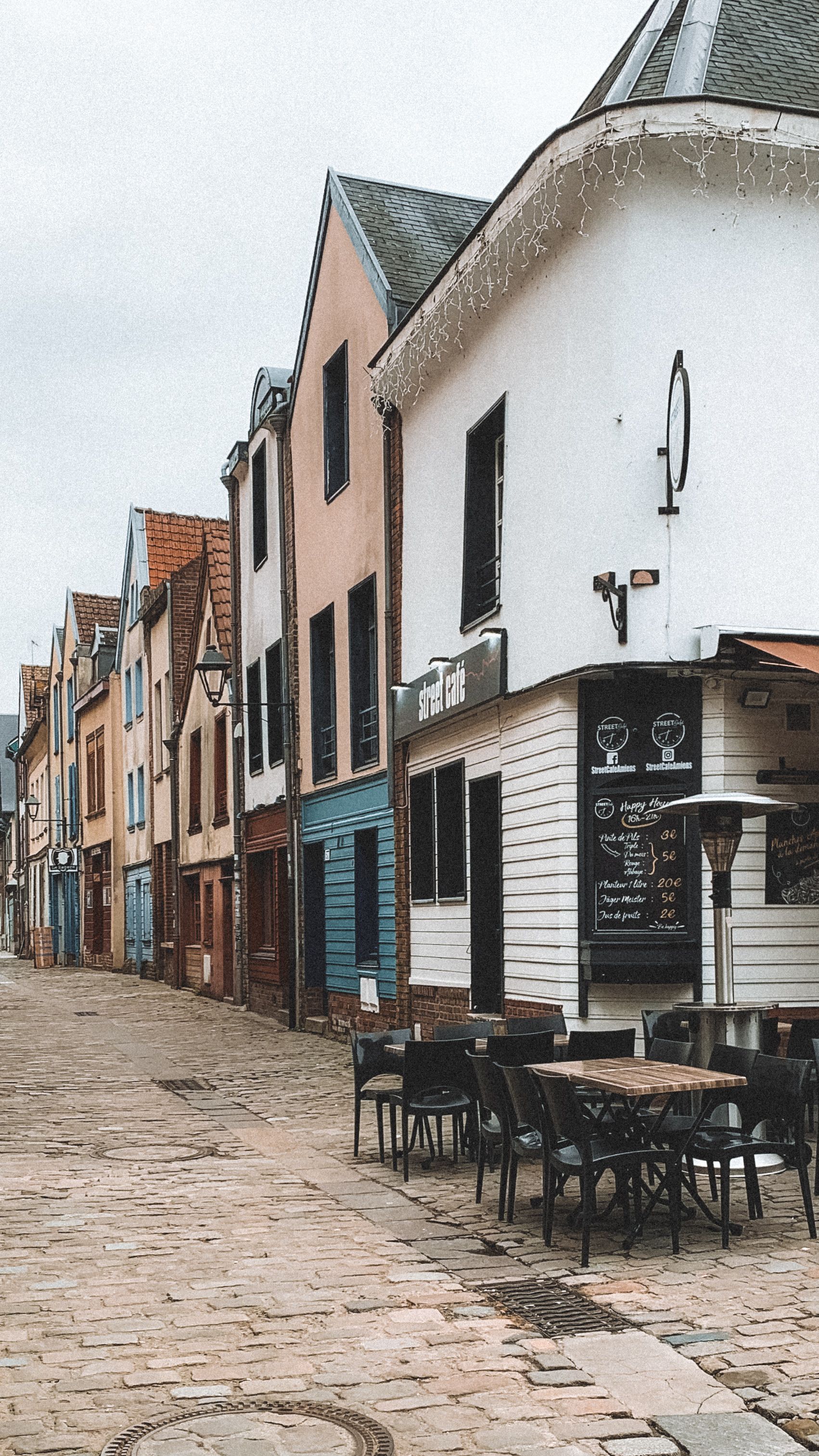 Charming European Street with Outdoor Cafe Seating · Free Stock Photo