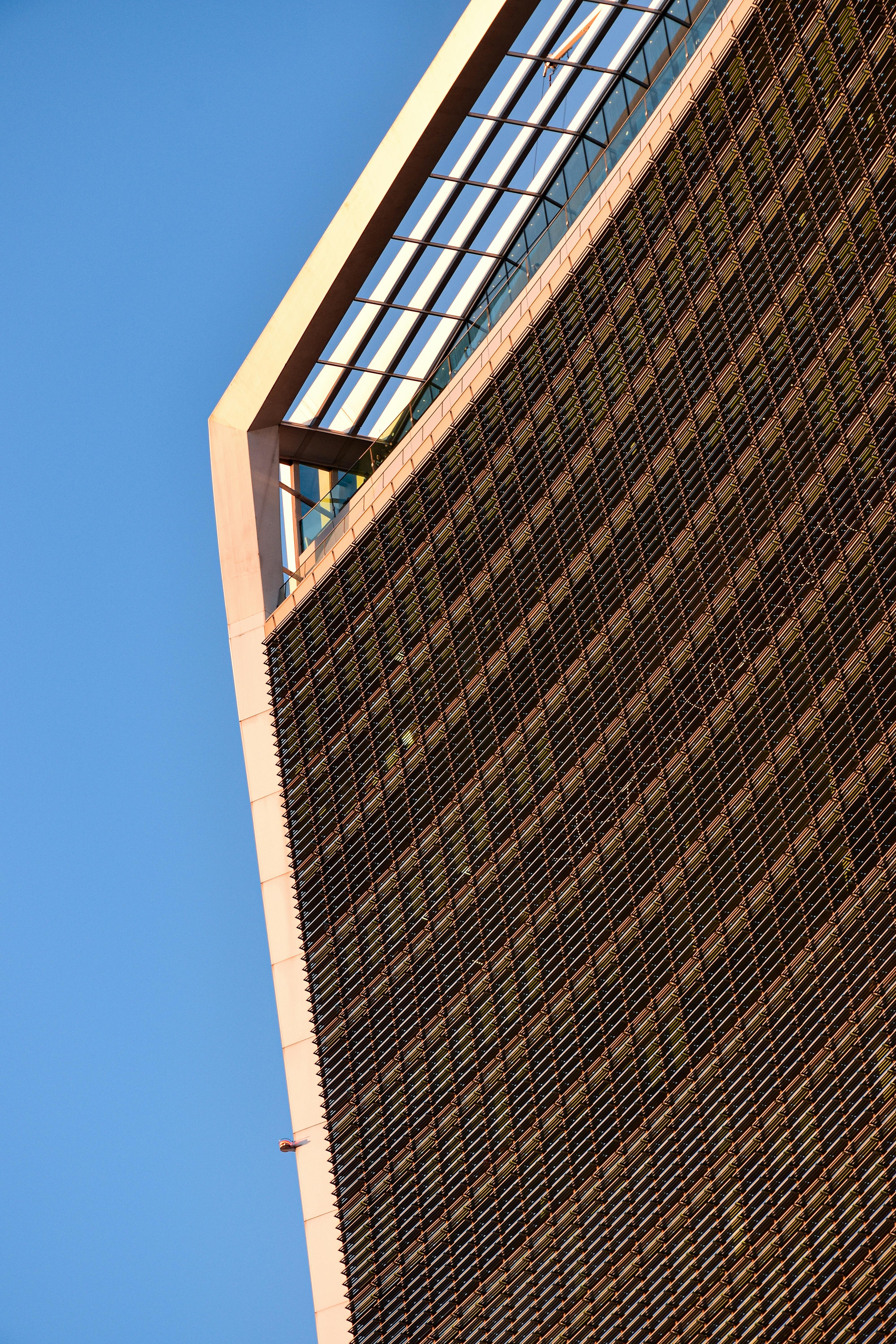 Modern Skyscraper Facade Against Blue Sky · Free Stock Photo