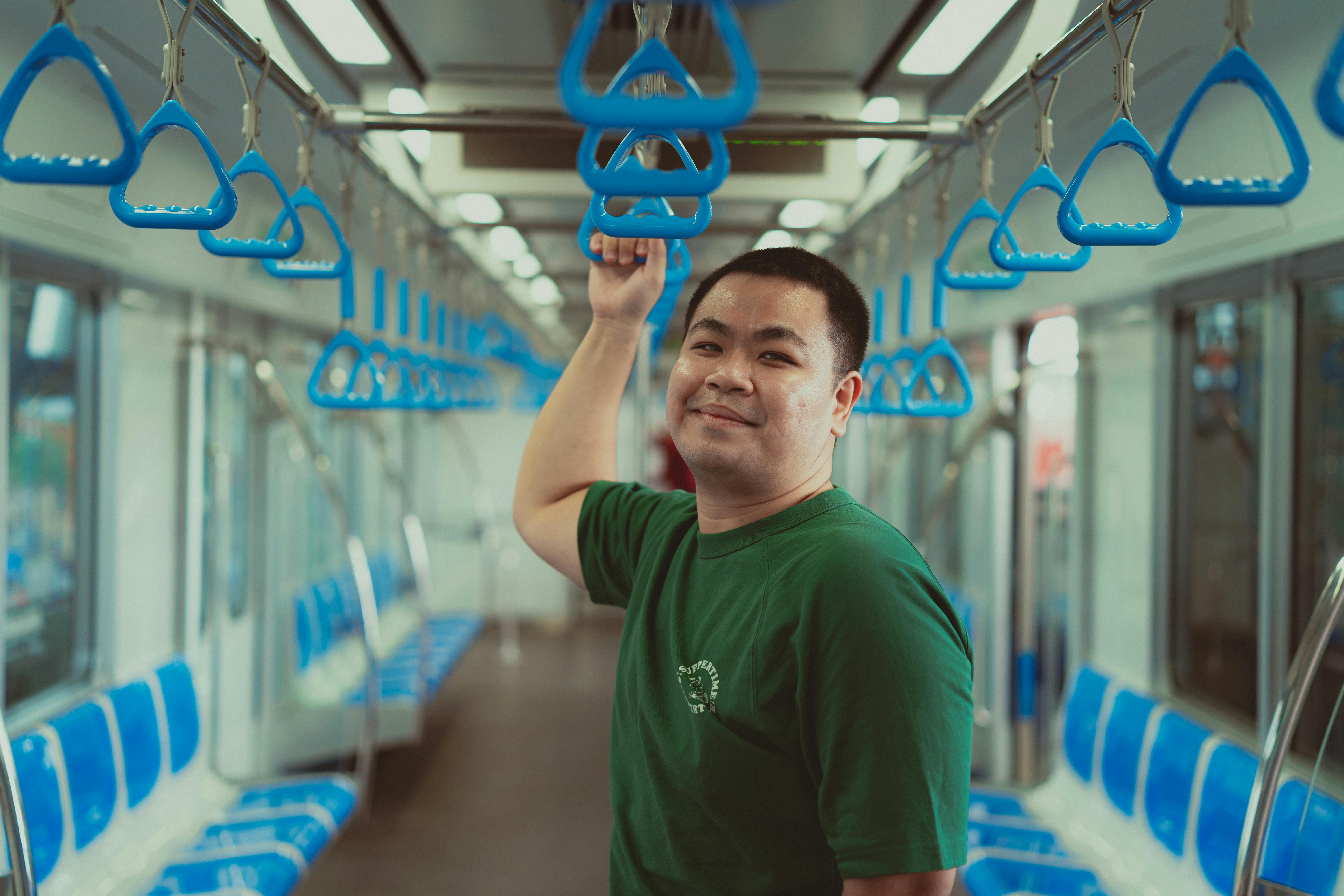 Man Holding Handrail in Ho Chi Minh City Metro · Free Stock Photo