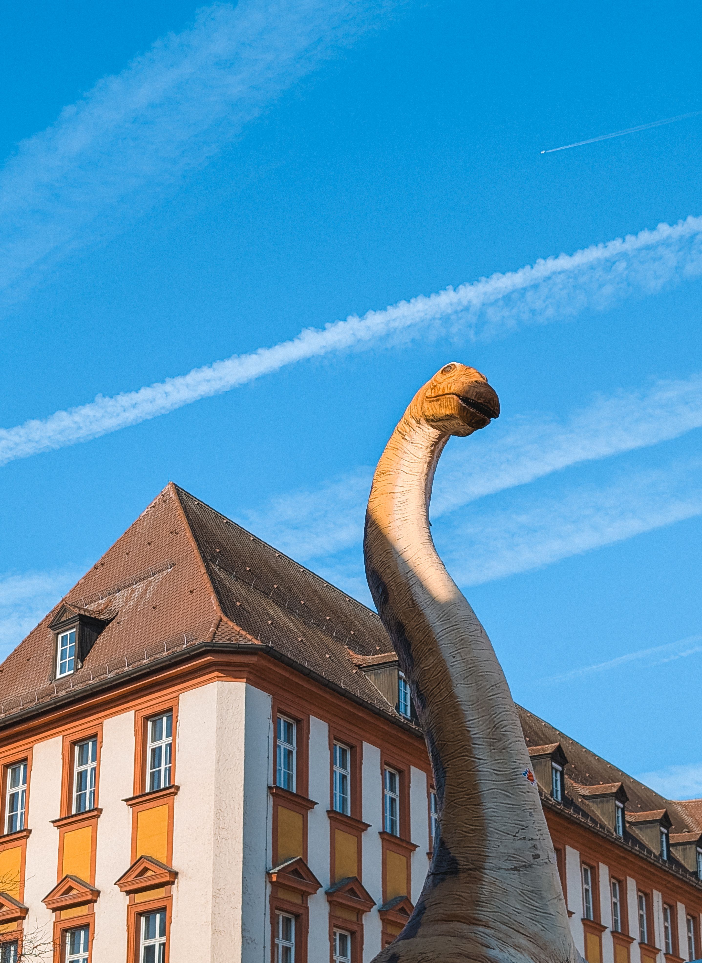 Brachiosaurus Statue with Historic Architecture · Free Stock Photo