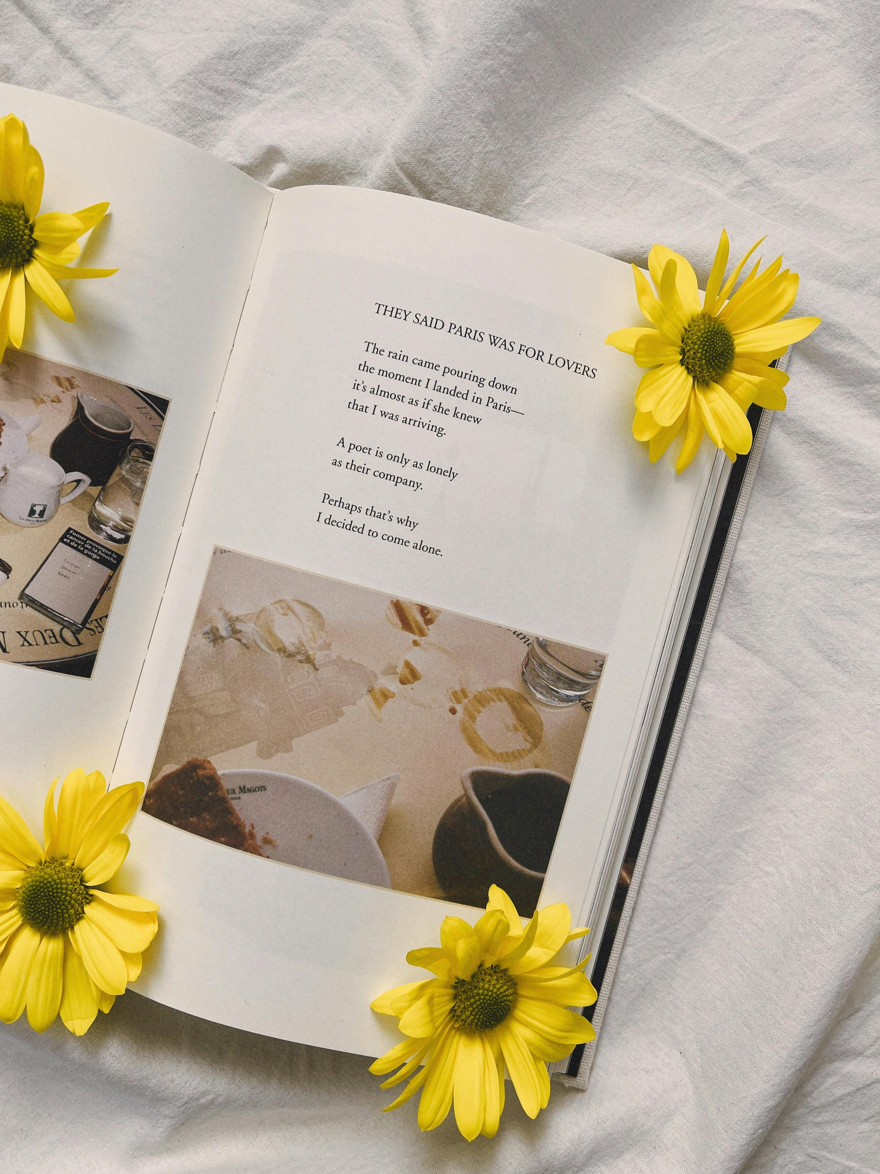 Open Book with Yellow Flowers and Poetry · Free Stock Photo