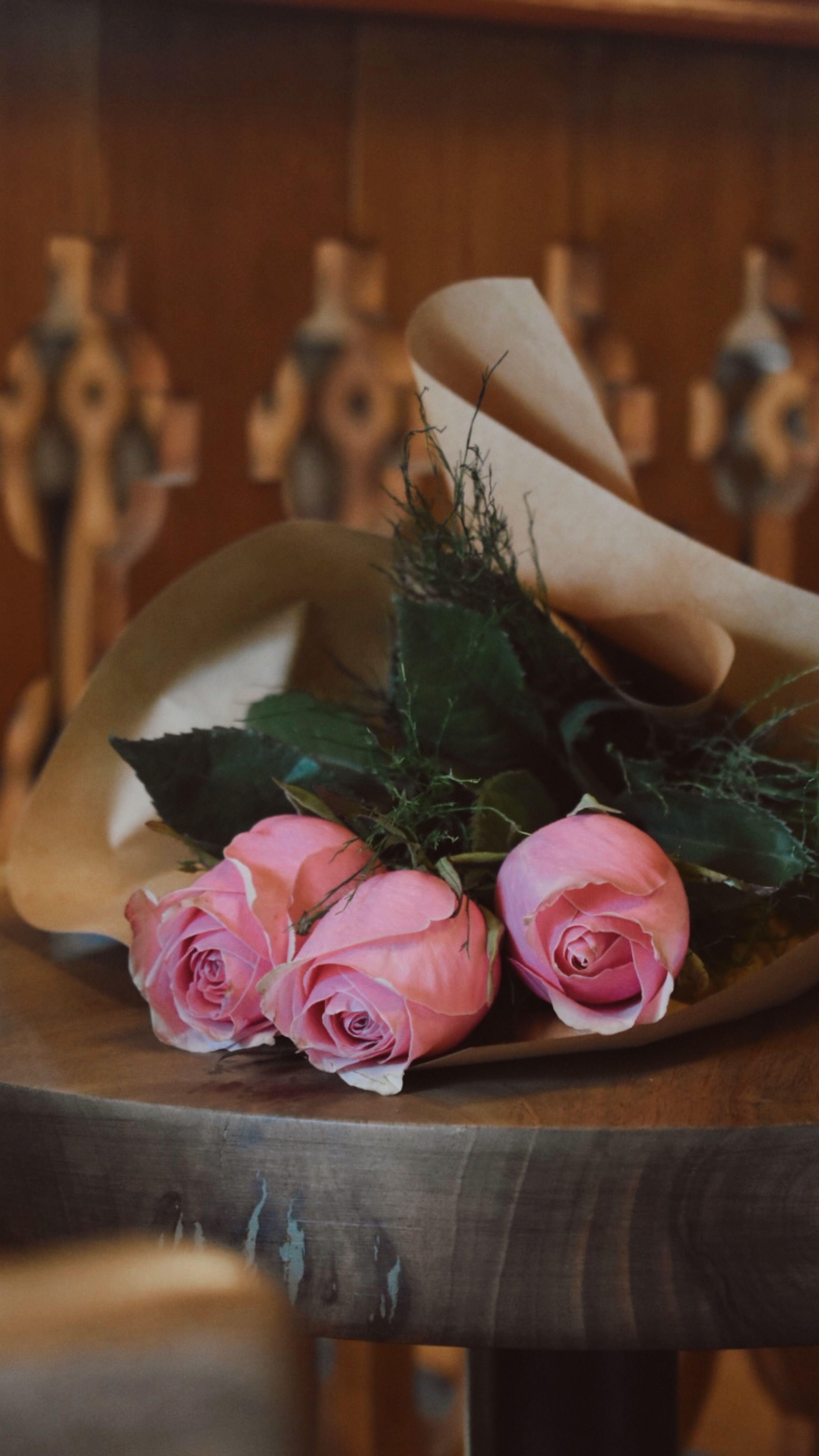 Elegant Pink Roses on Rustic Wooden Table · Free Stock Photo