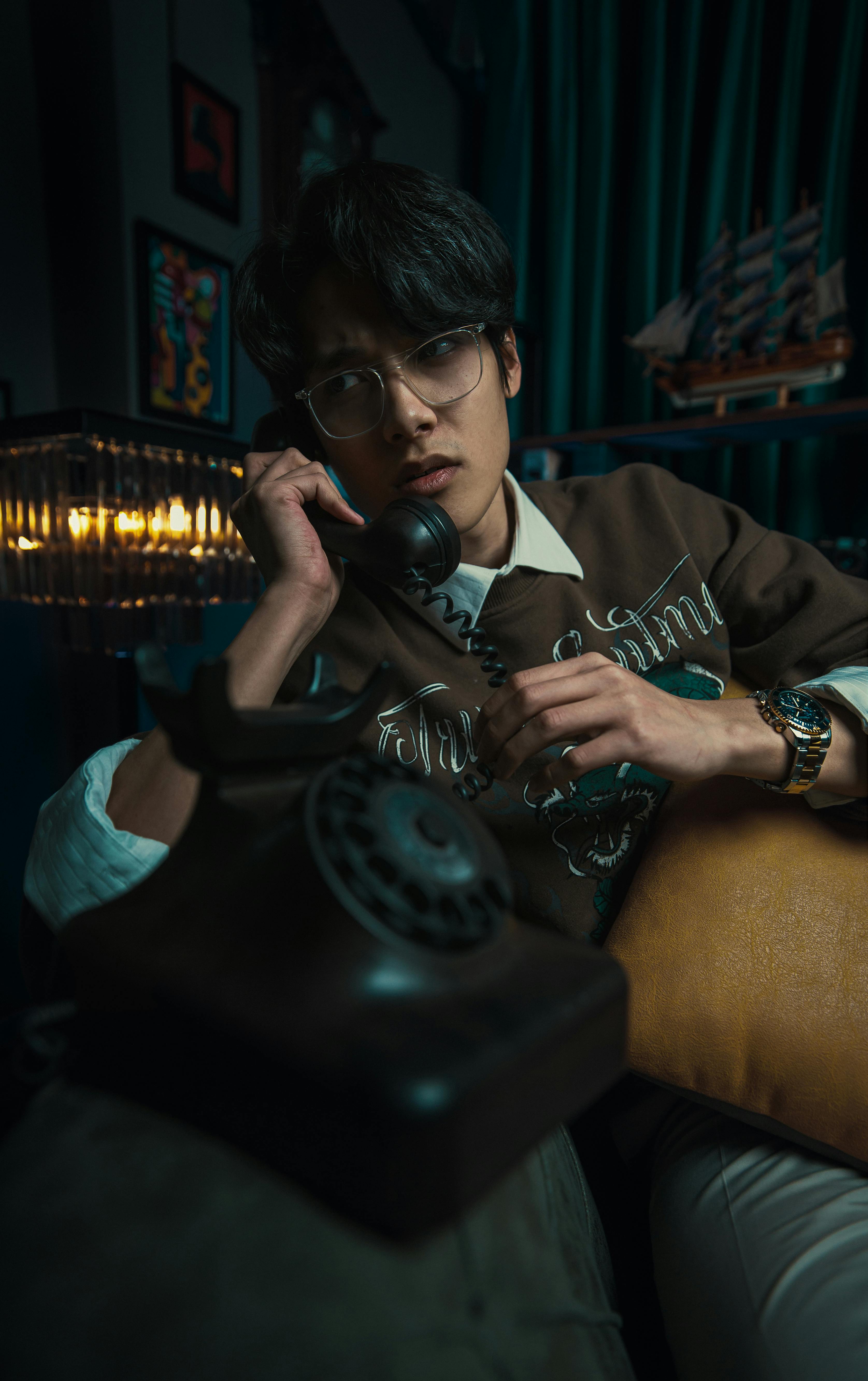Vintage Style Man on Telephone in Moody Lighting · Free Stock Photo