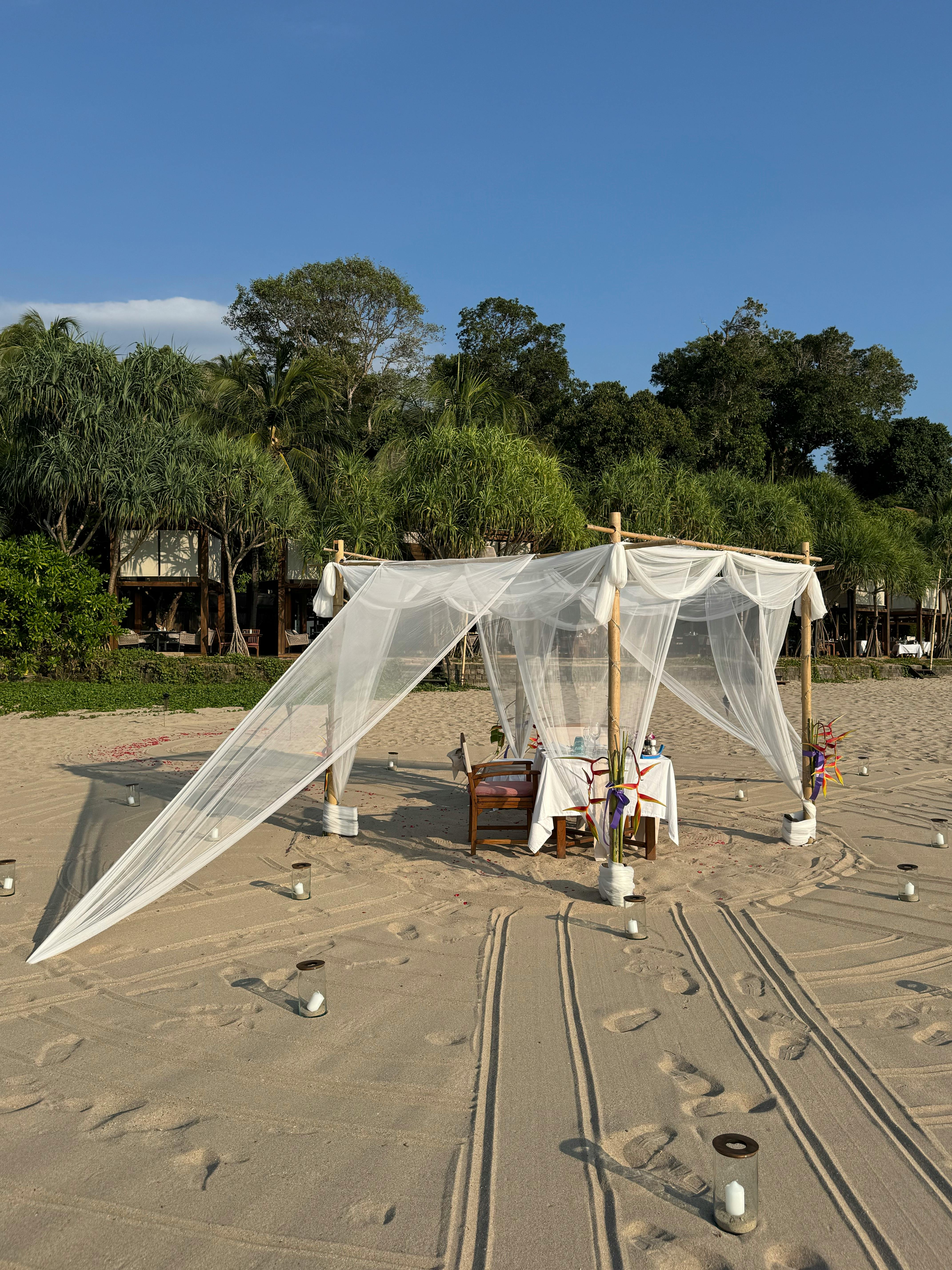 Romantic Beachside Canopy Setup at Sunset · Free Stock Photo