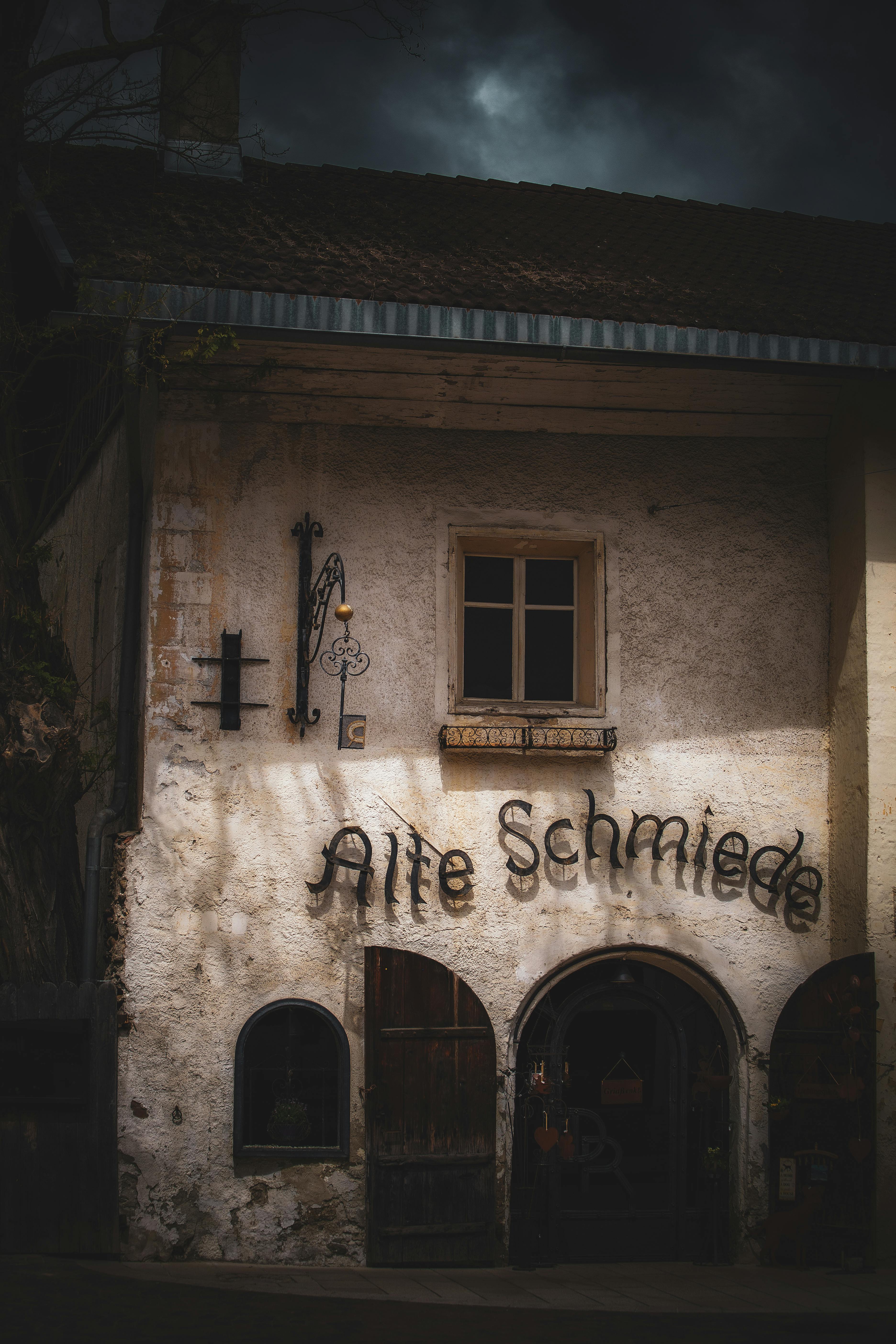 Rustic European Building with Historic Signage · Free Stock Photo