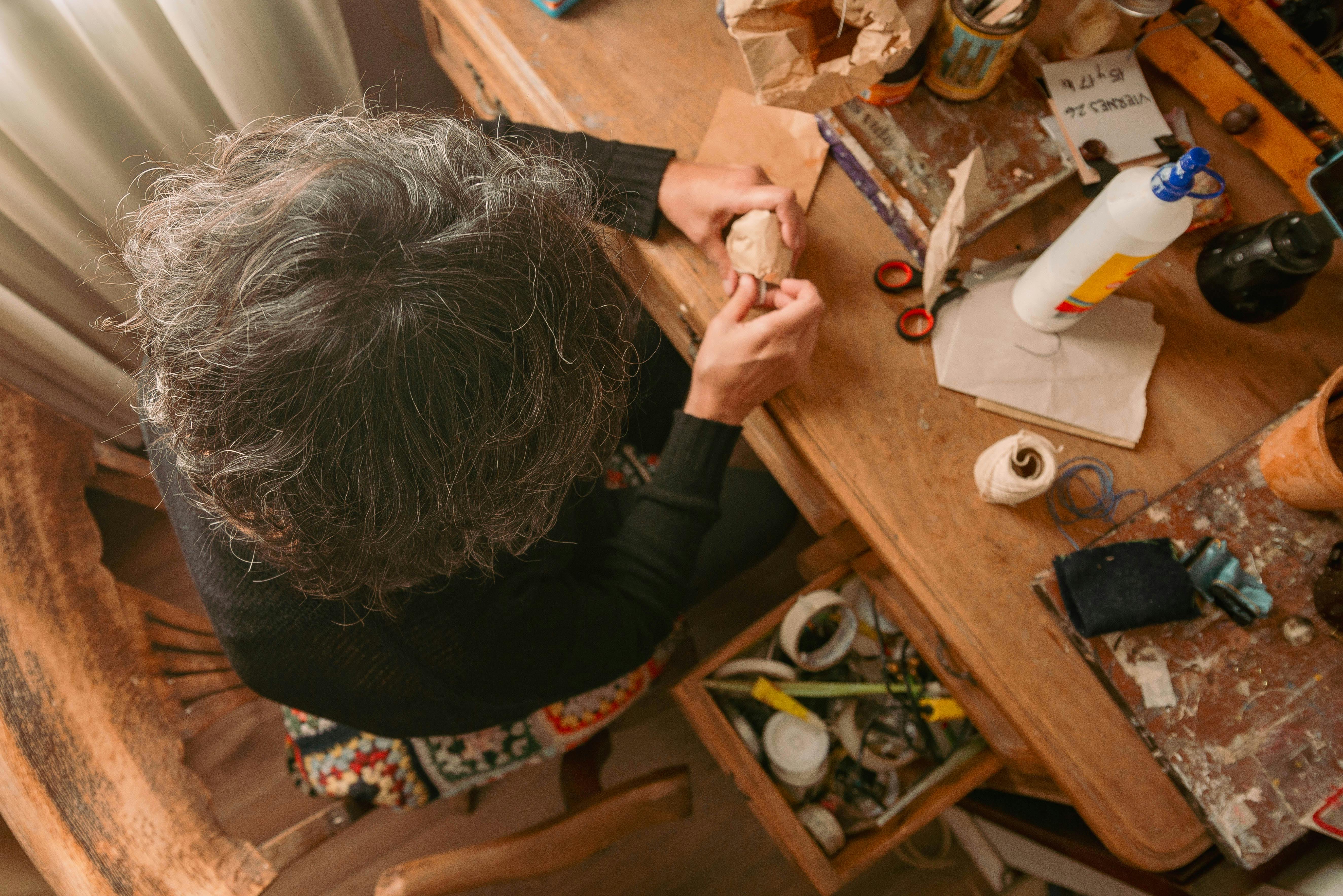 Artisan Handcrafting at Wooden Desk · Free Stock Photo