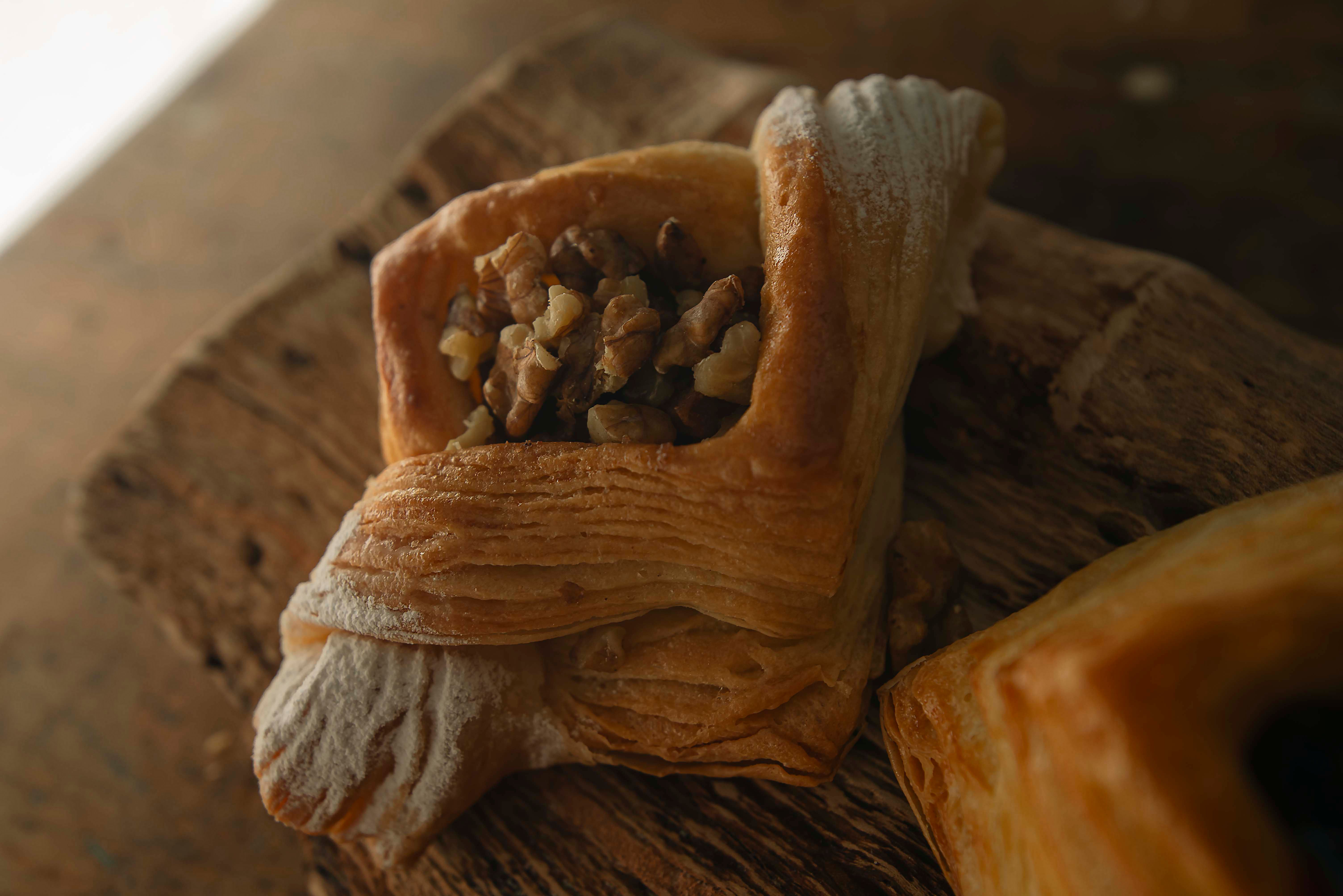 Rustic Walnut Puff Pastry on Wooden Surface · Free Stock Photo