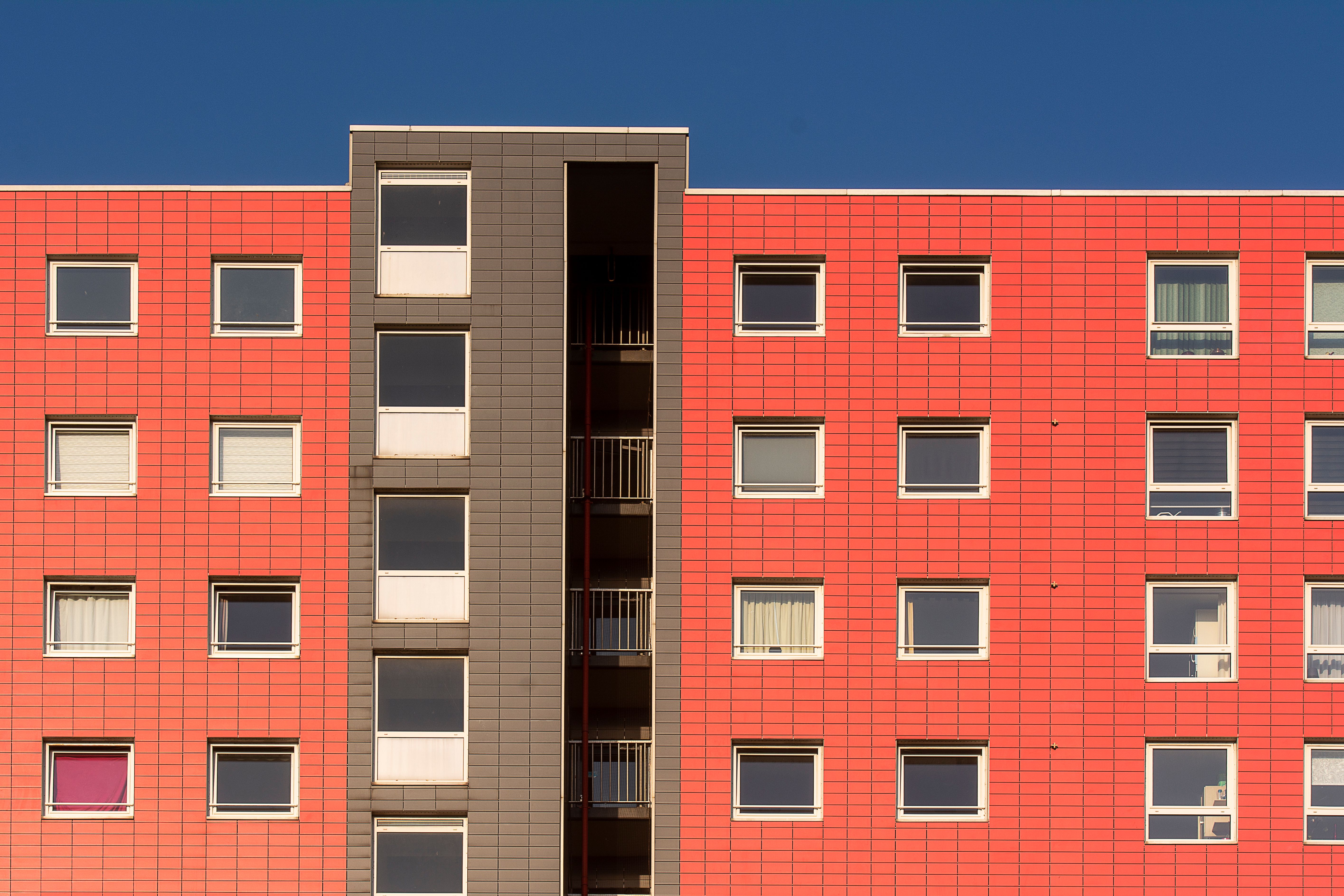 Modern Red Apartment Building Facade · Free Stock Photo