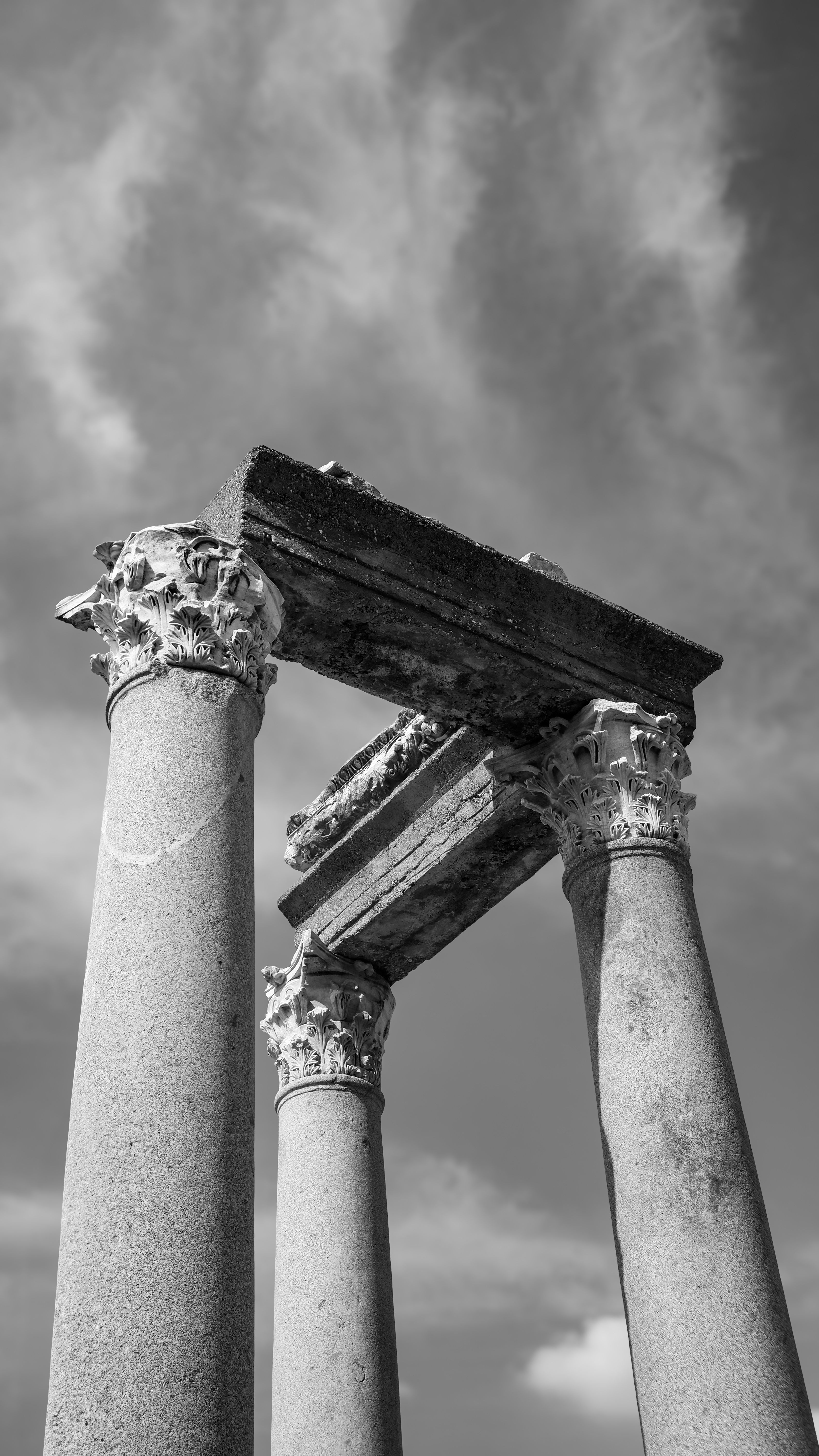 Ancient Roman Columns Against Dramatic Sky · Free Stock Photo