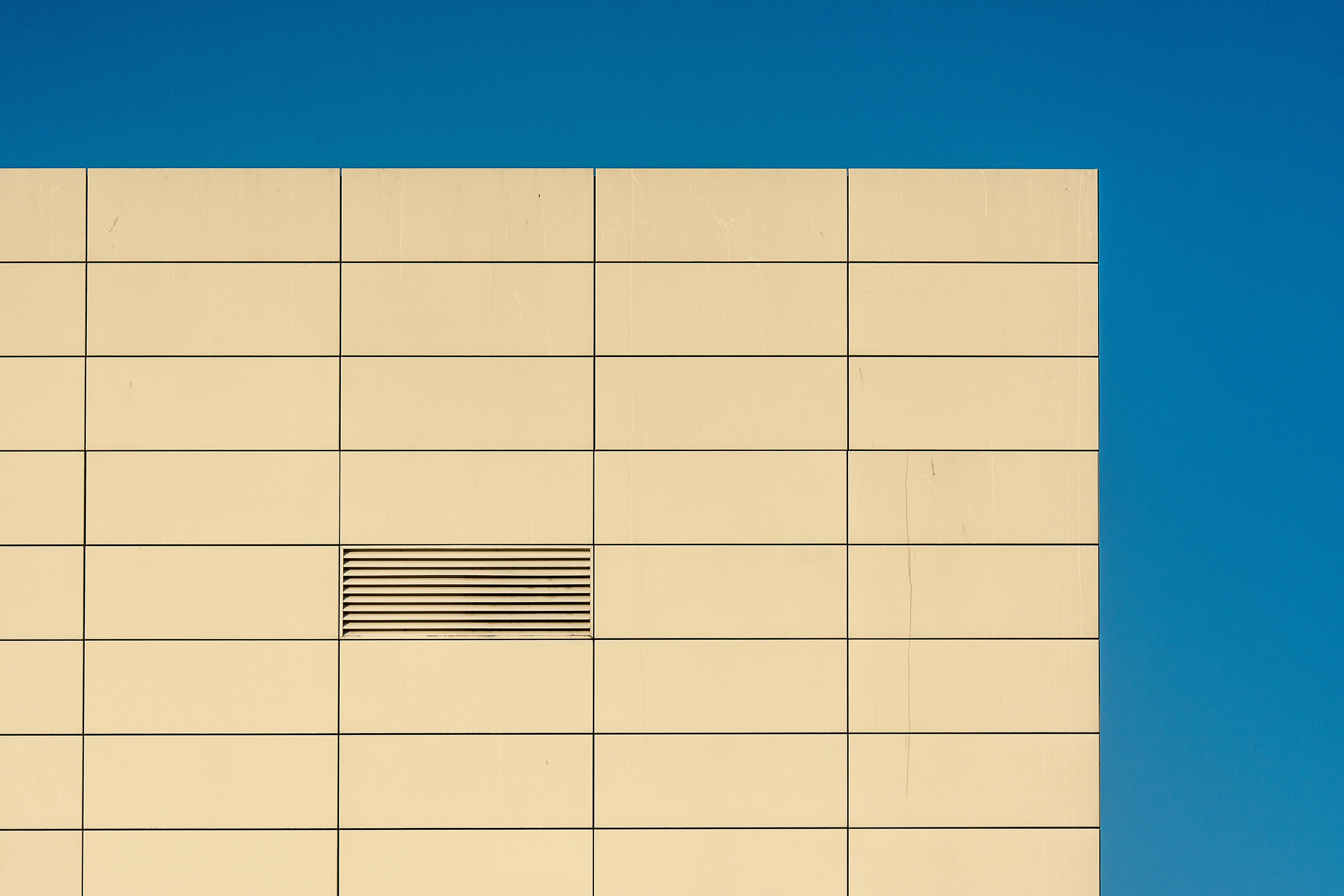 Minimalist Building Facade Against Clear Sky · Free Stock Photo