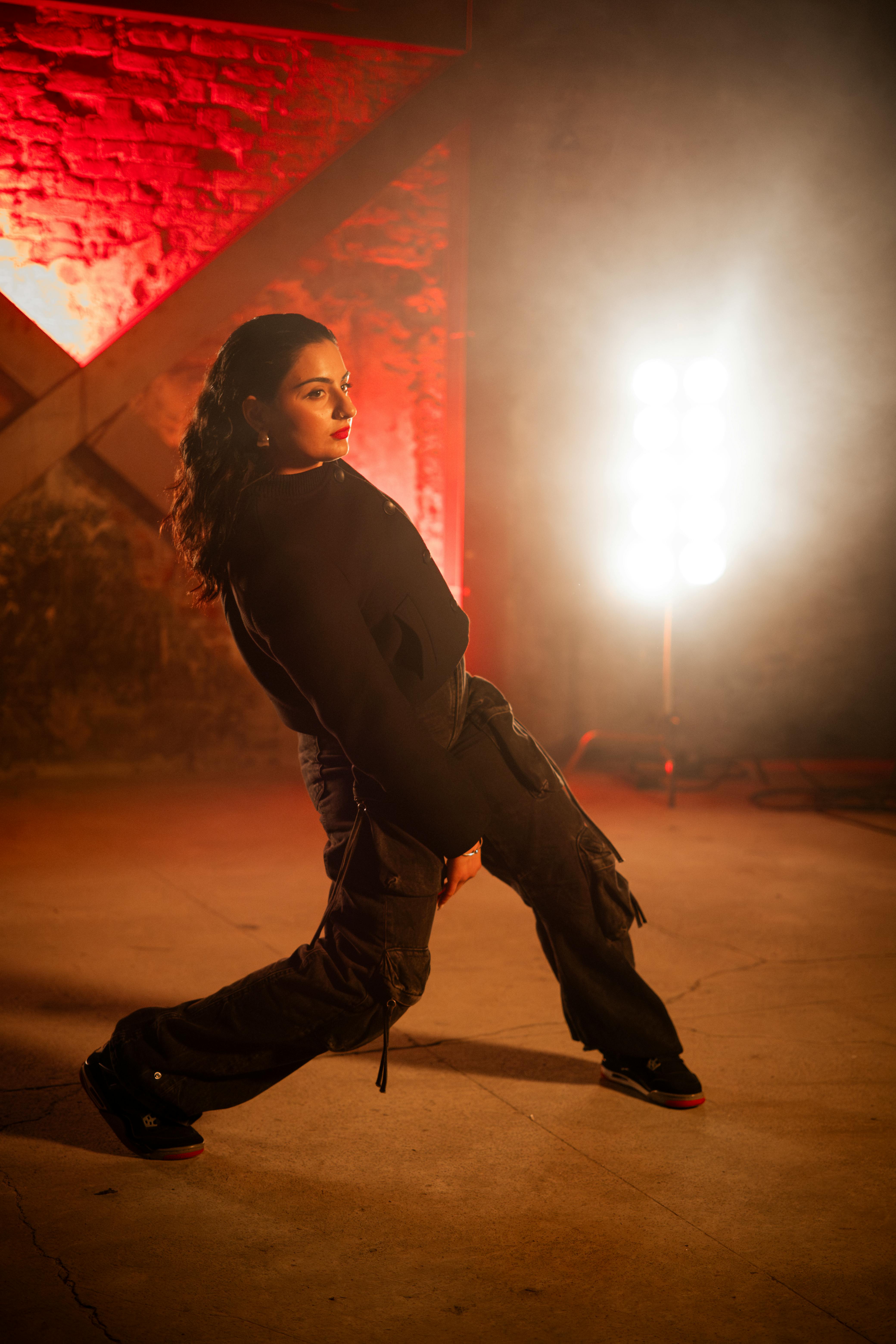 Dynamic Dance Pose in Dramatic Lighting · Free Stock Photo