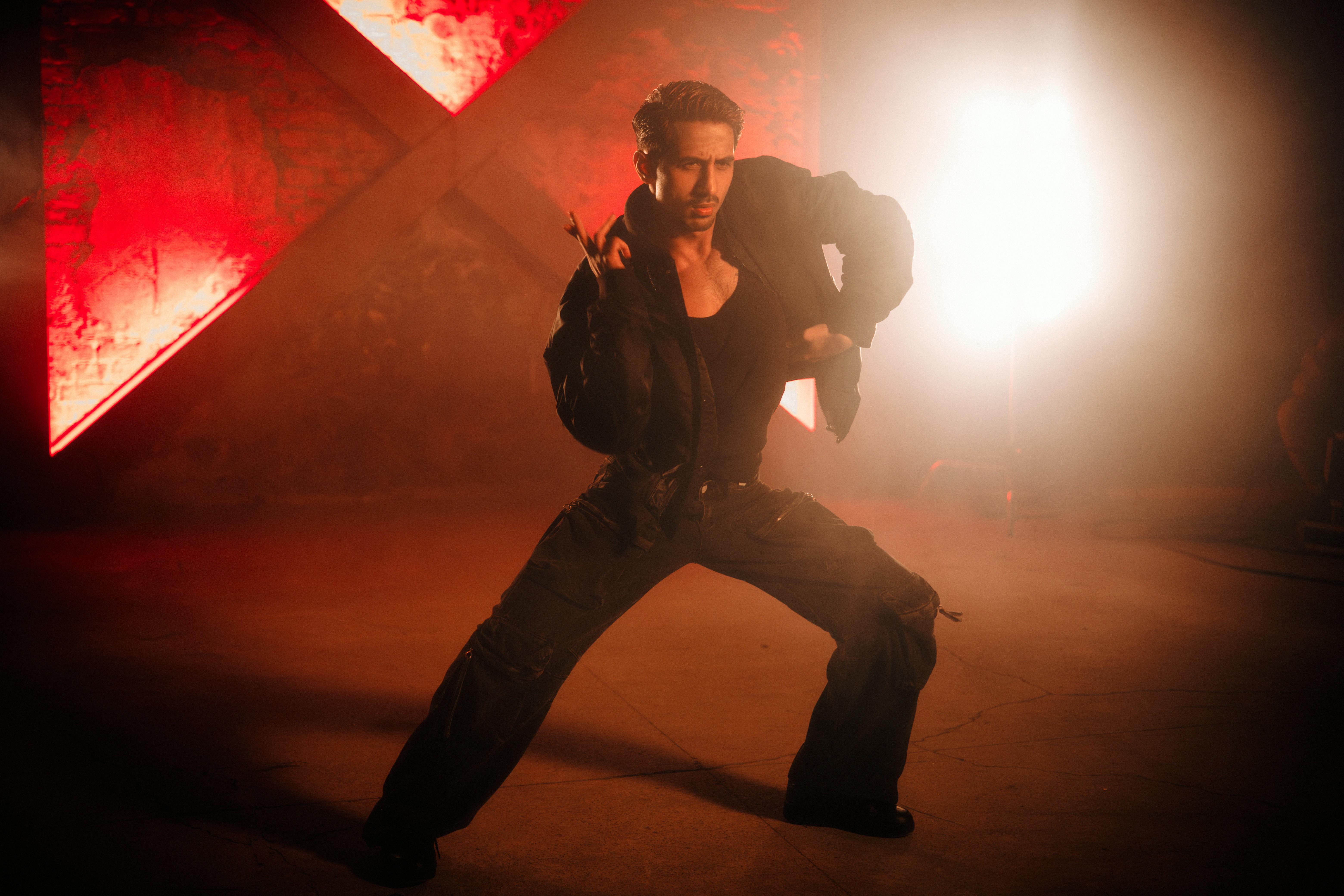 Dynamic Dancer Posing in Dramatic Lighting · Free Stock Photo