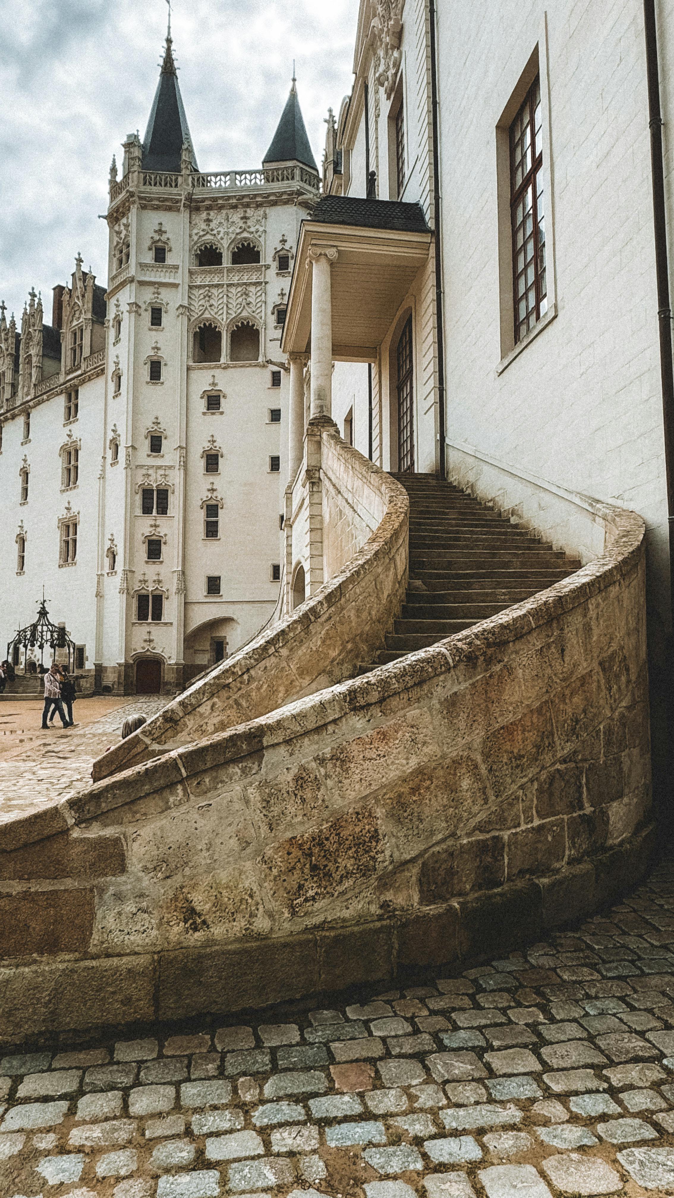 Historic European Castle with Stone Staircase · Free Stock Photo