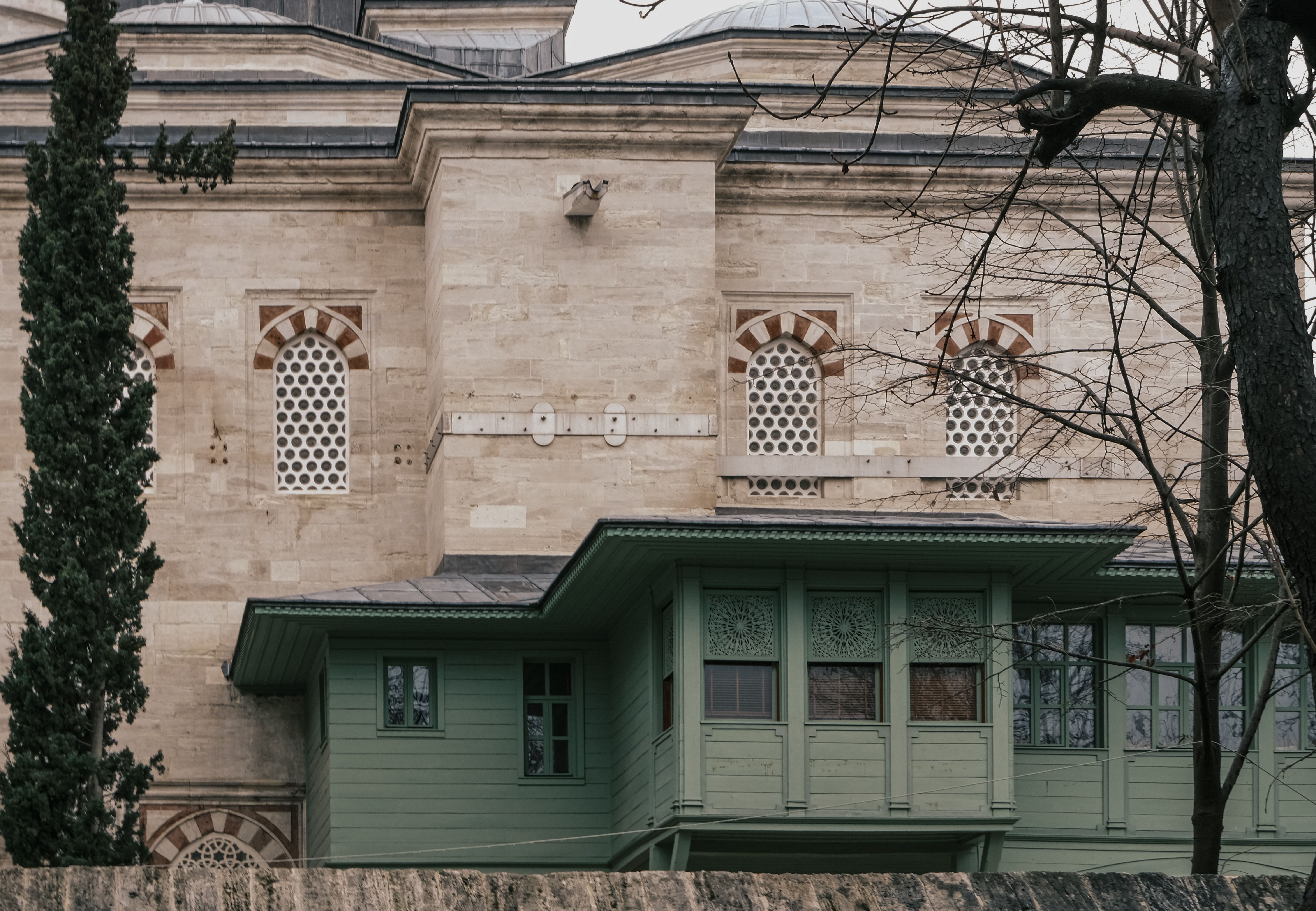 Historic Stone Building with Olive Green Addition · Free Stock Photo