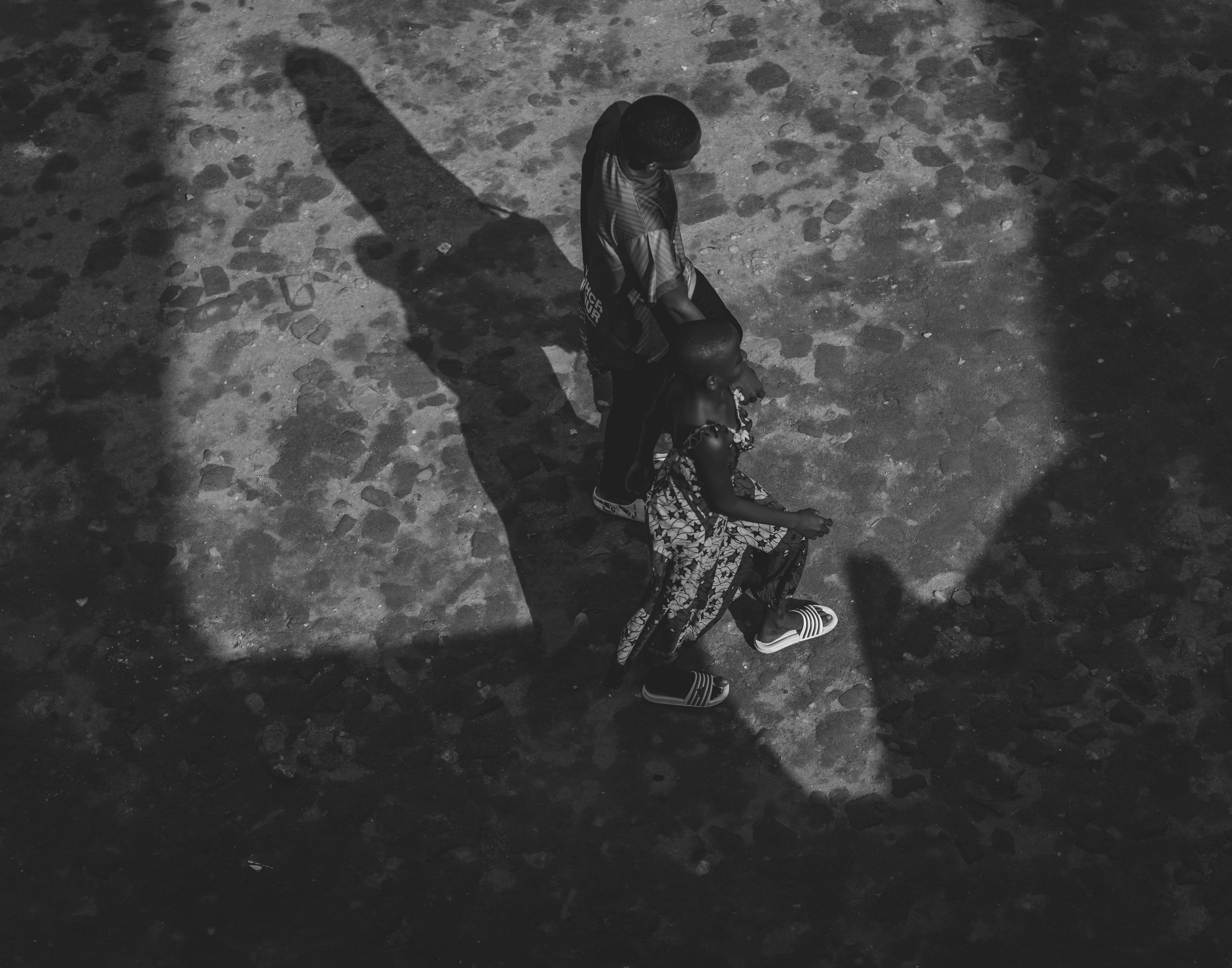 Aerial View of People Walking in Shadows · Free Stock Photo
