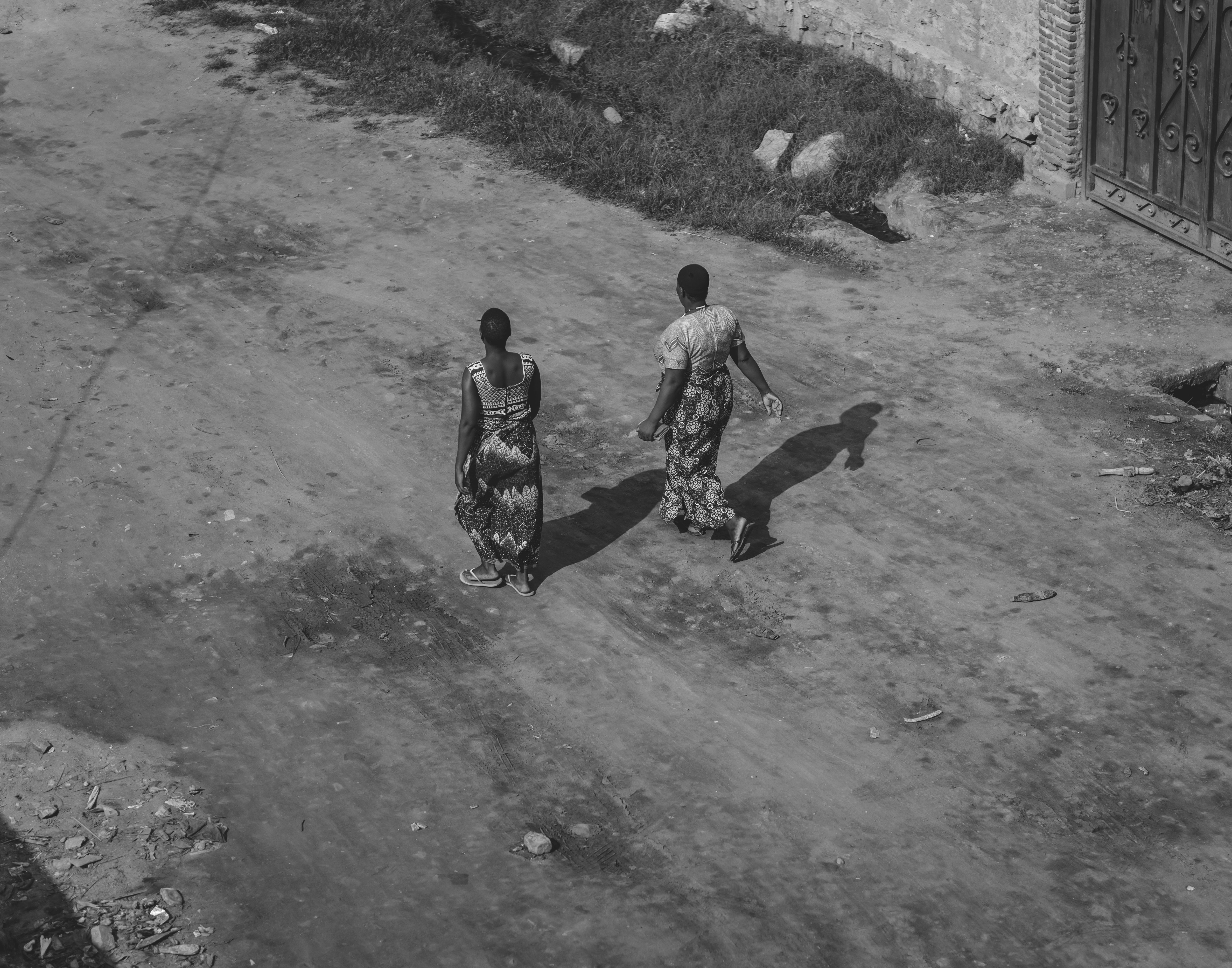 Two People Walking on a Dirt Road in Monochrome · Free Stock Photo