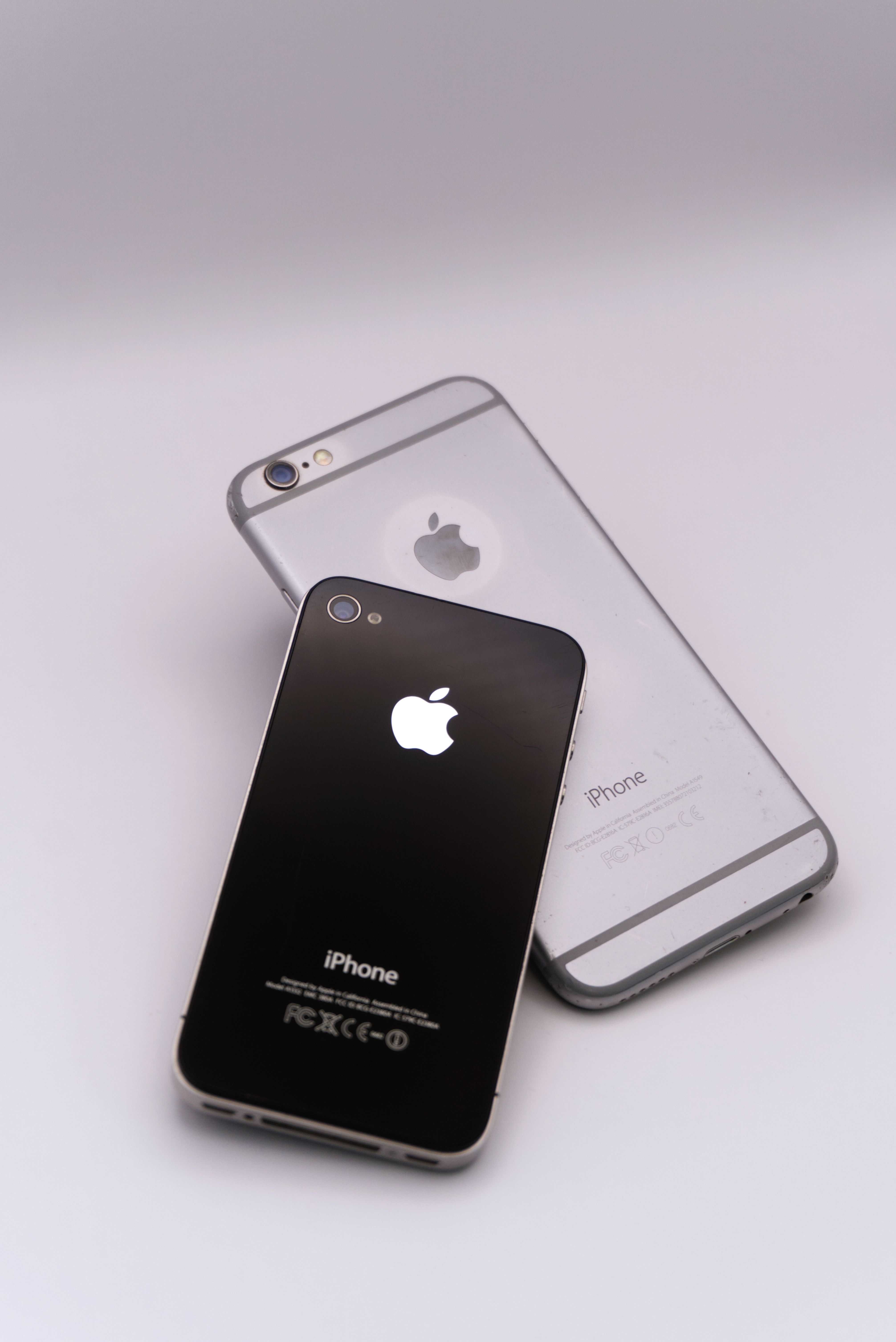 Close-up of Two Smartphones on White Surface · Free Stock Photo