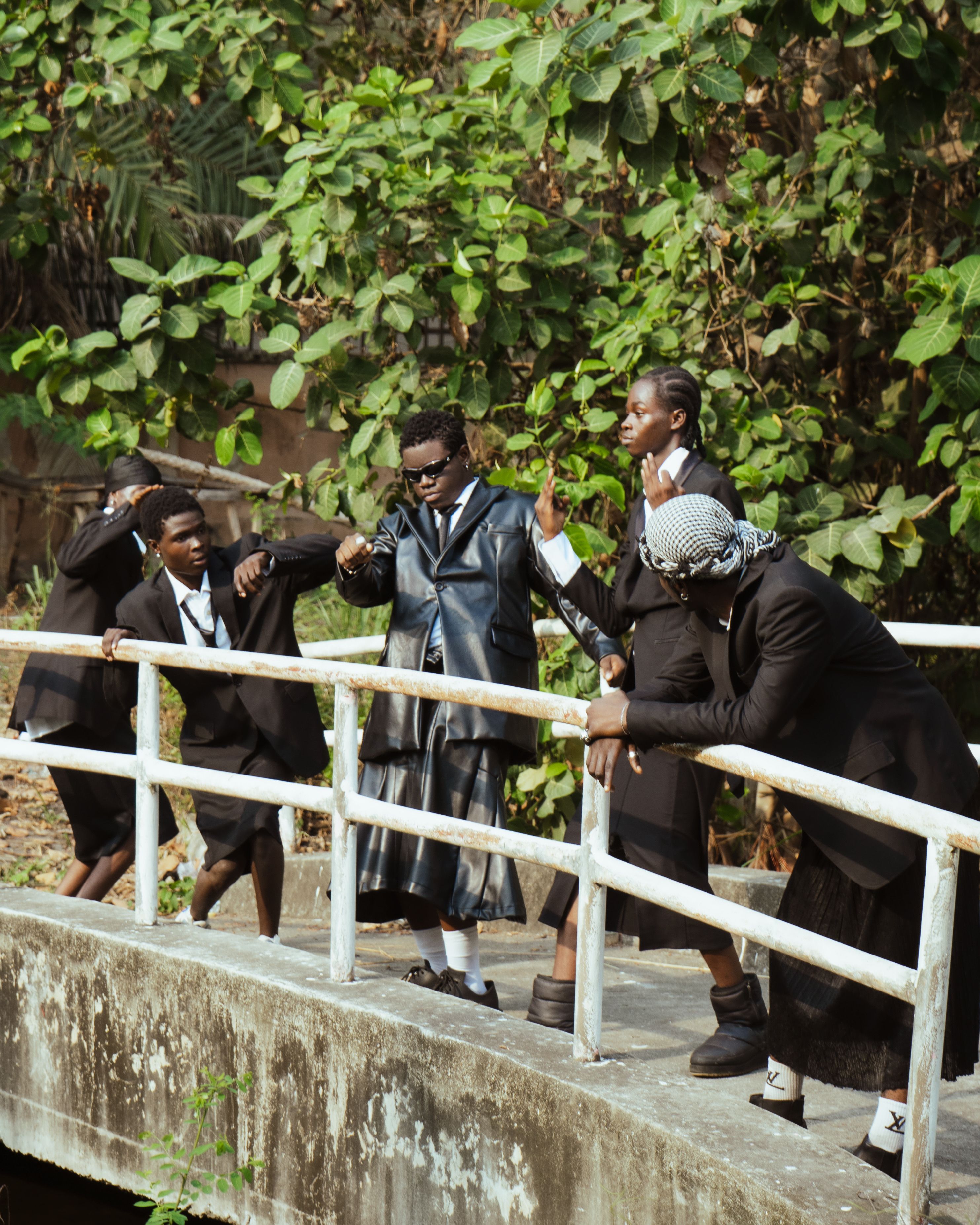 Fashionable Group in Stylish Outfits on Bridge · Free Stock Photo