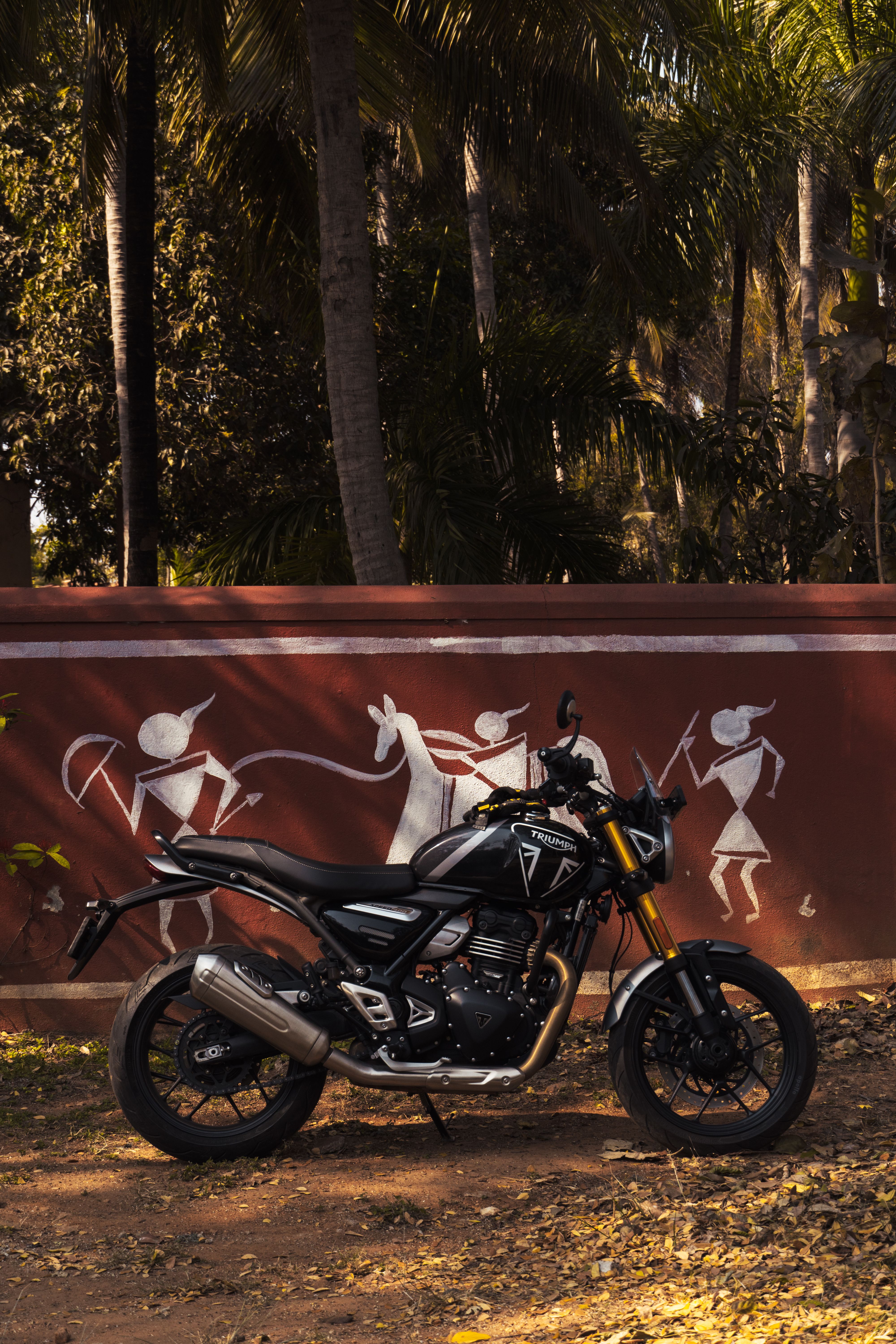 Black Motorcycle in Front of Tribal Art Wall · Free Stock Photo
