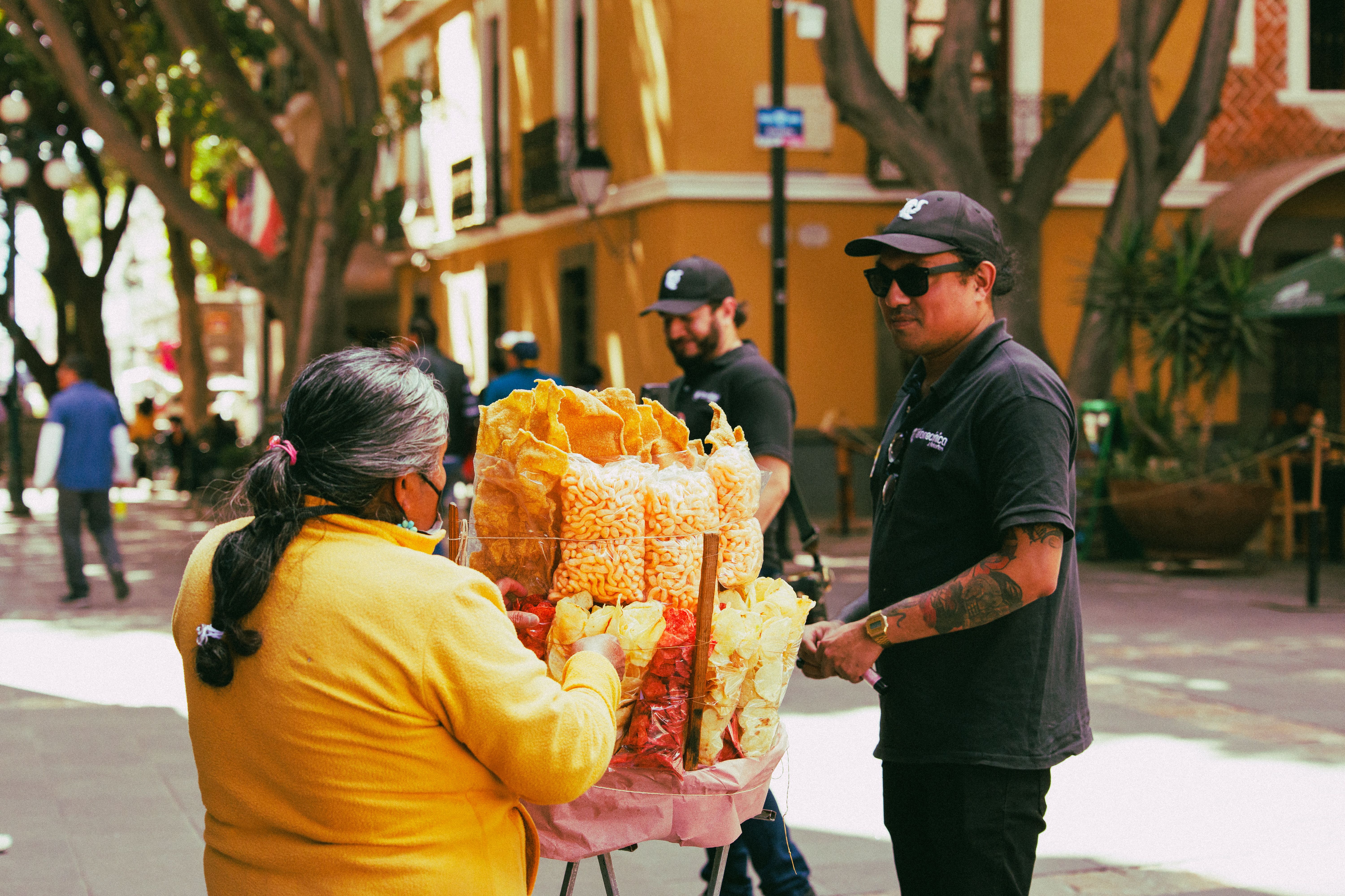 Street Vendor Selling Snacks in Puebla Plaza · Free Stock Photo