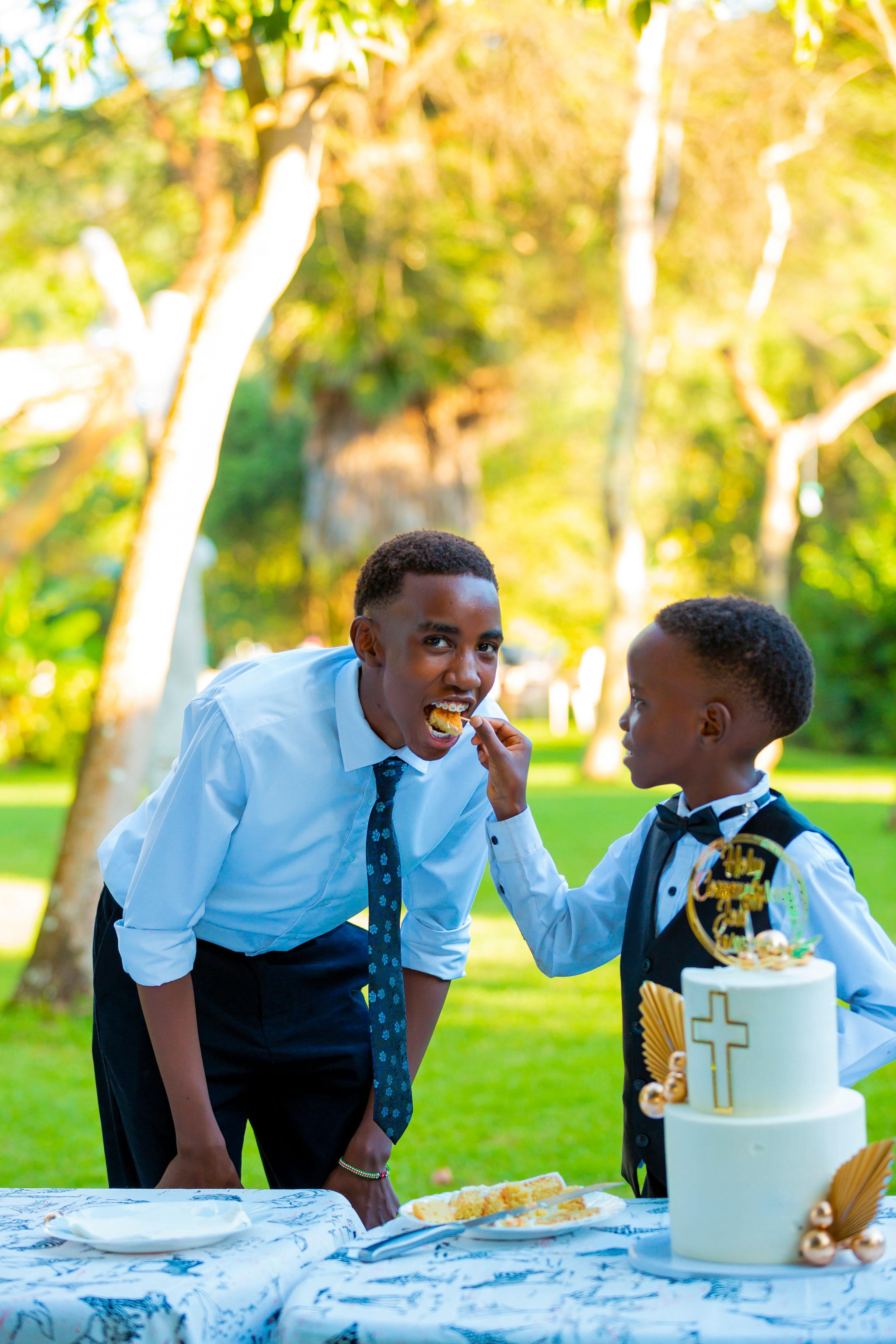Joyful Celebration with Cake Cutting Ceremony · Free Stock Photo