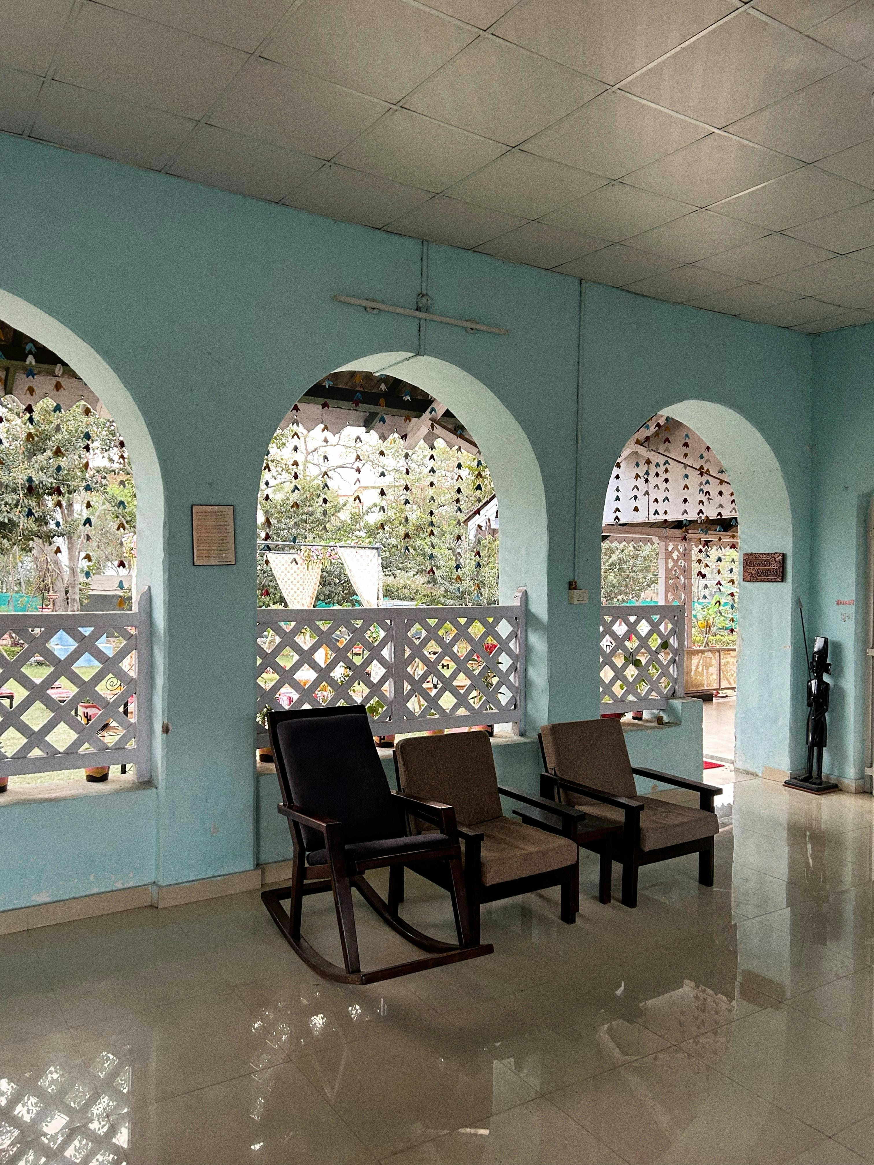 Cozy Indoor Seating Area with Arched Windows · Free Stock Photo