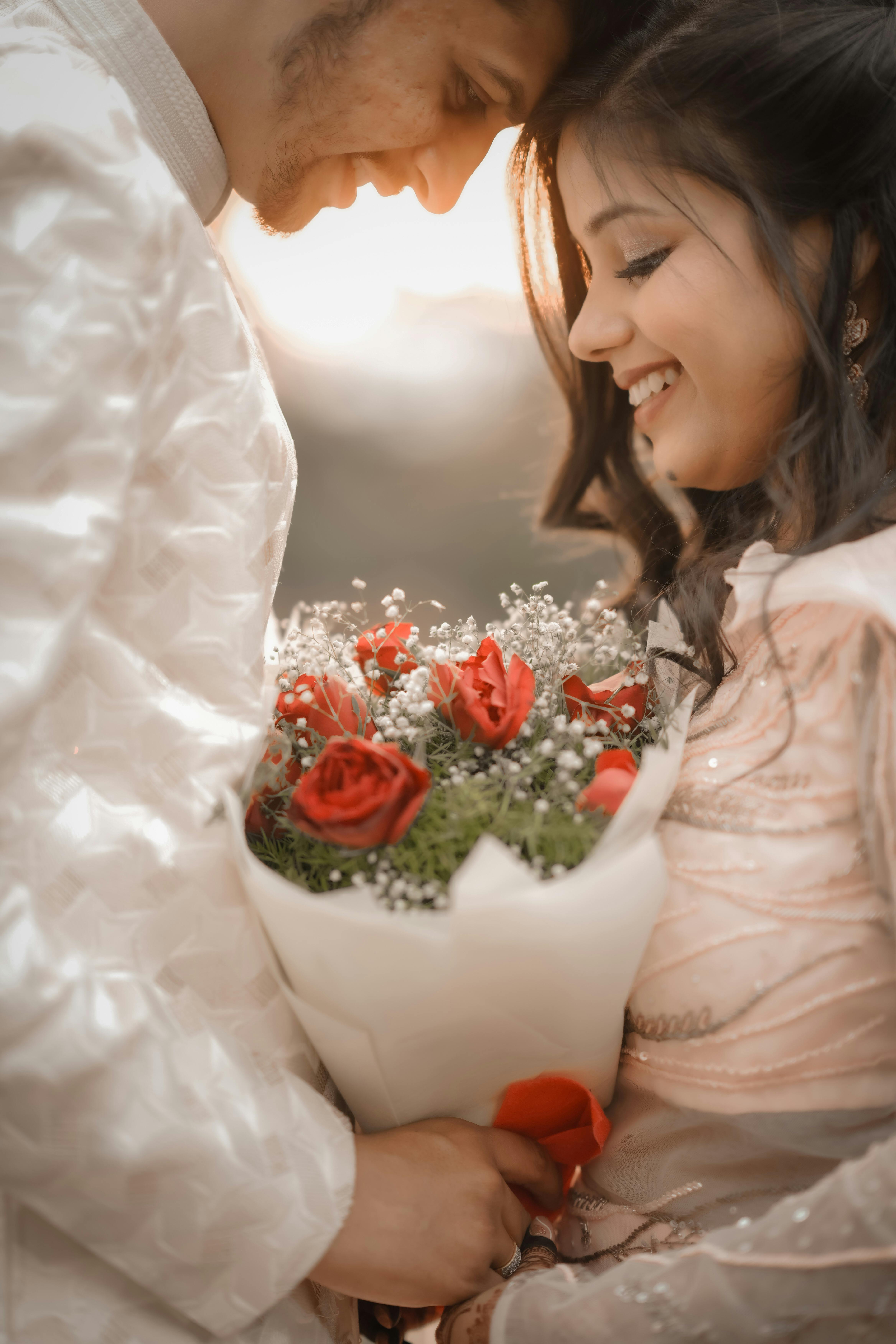 Romantic Couple Embracing with Rose Bouquet · Free Stock Photo