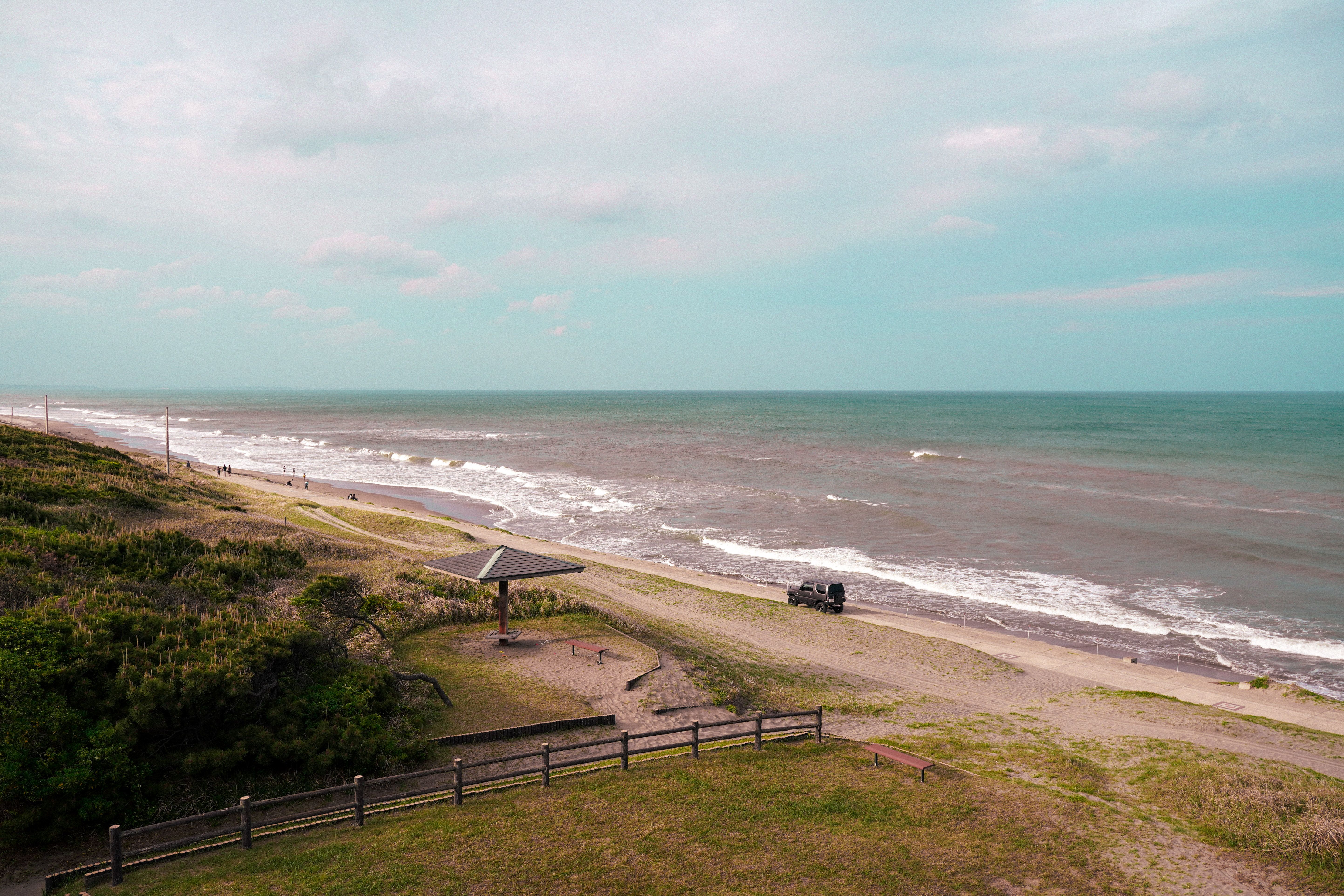 Coastal Landscape with Ocean Waves and Beachfront Path · Free Stock Photo