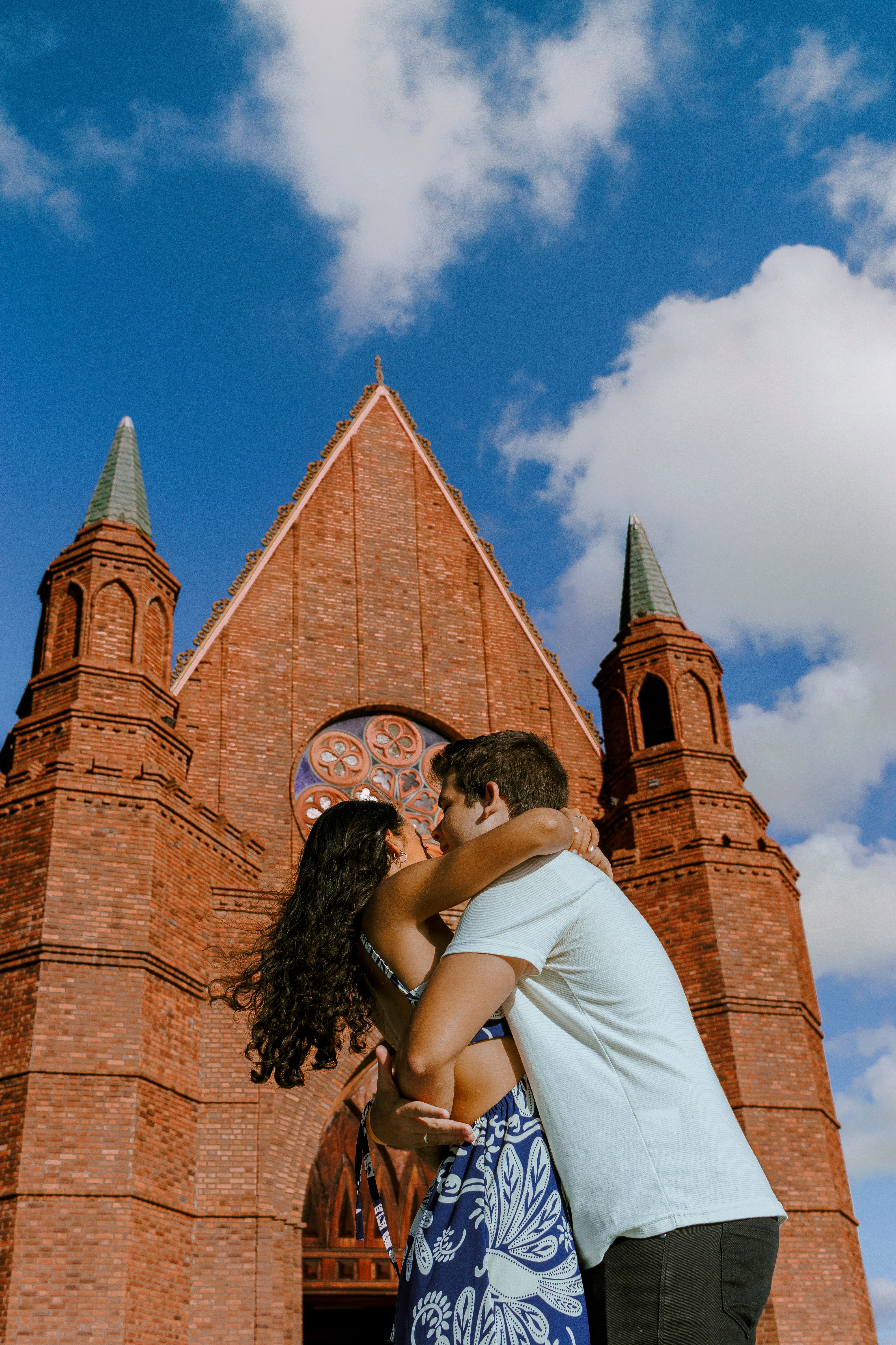 Romantic Couple Embracing in Front of Historic Church · Free Stock Photo